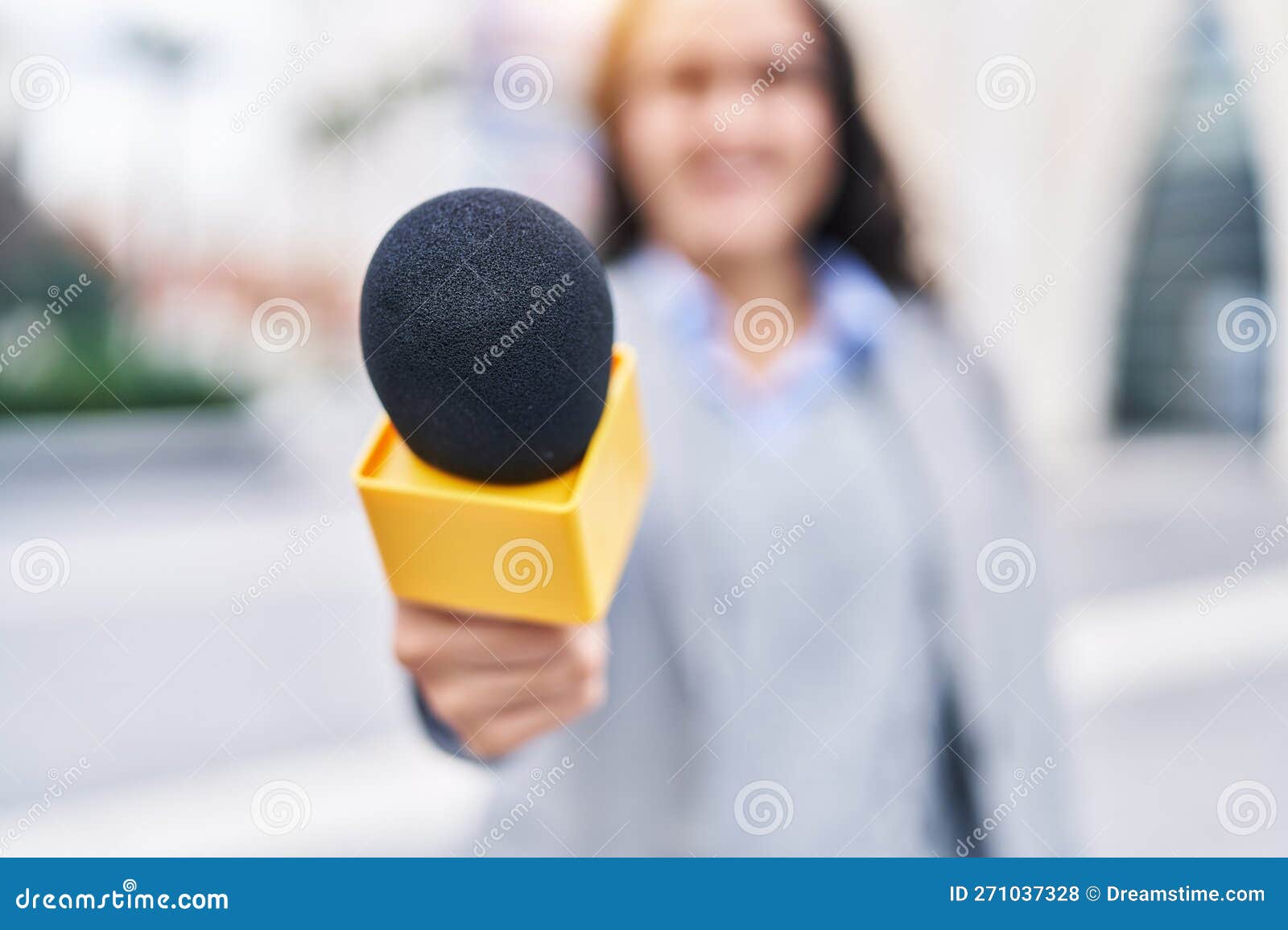 Young Hispanic Woman Reporter Working Using Microphone at Street Stock ...