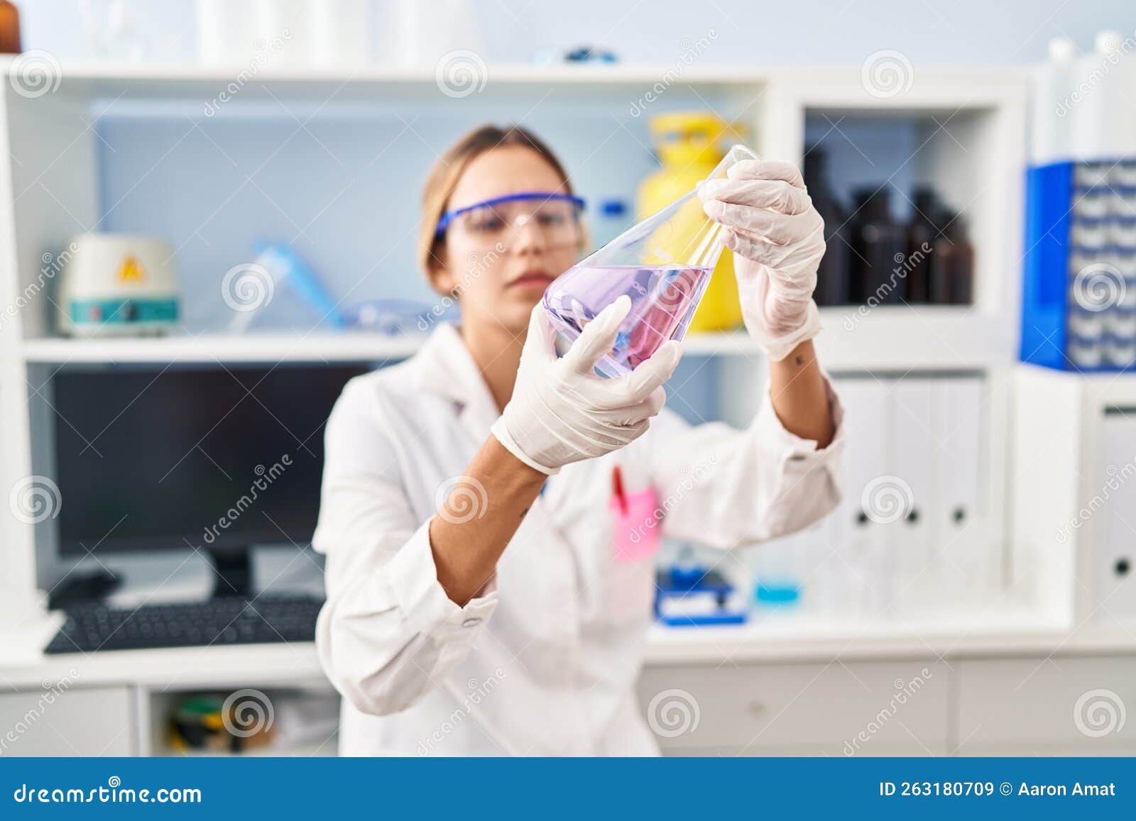 Young Hispanic Woman Scientist Measuring Liquid at Laboratory Stock ...