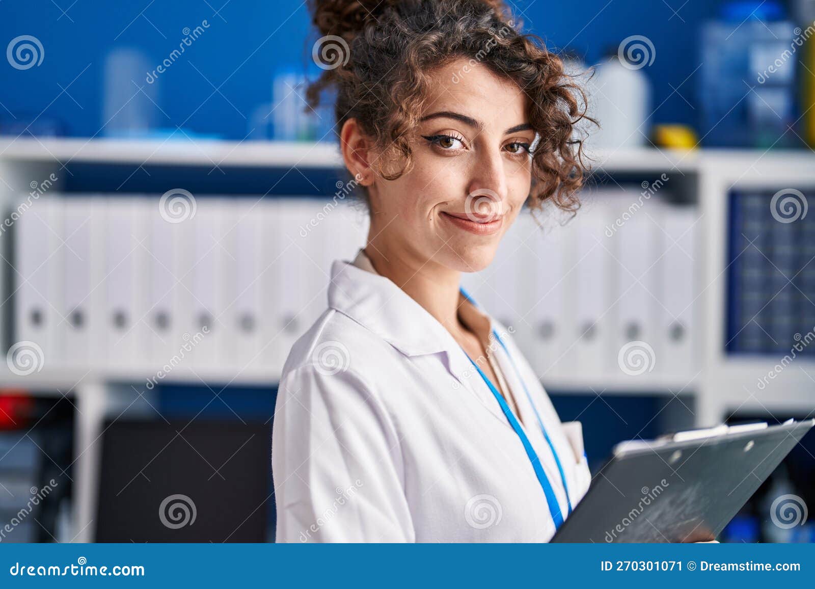 Young Hispanic Woman Scientist Smiling Confident Reading Document at ...