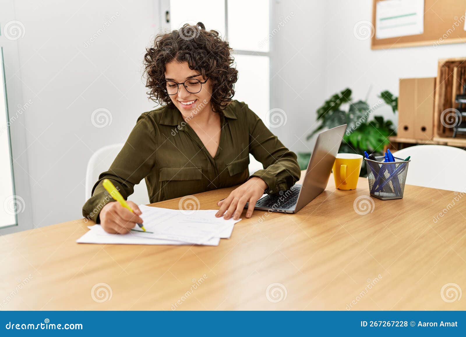 Young Hispanic Woman Smiling Confident Writing on Document at Office ...