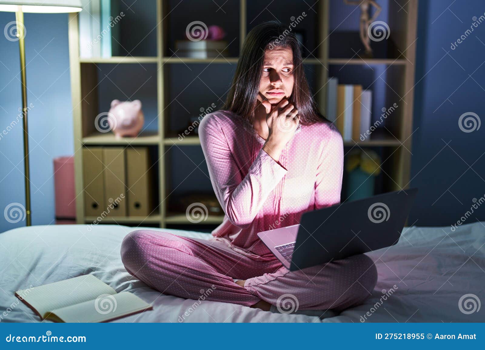 Young Hispanic Woman Using Computer Laptop on the Bed Looking Stressed ...
