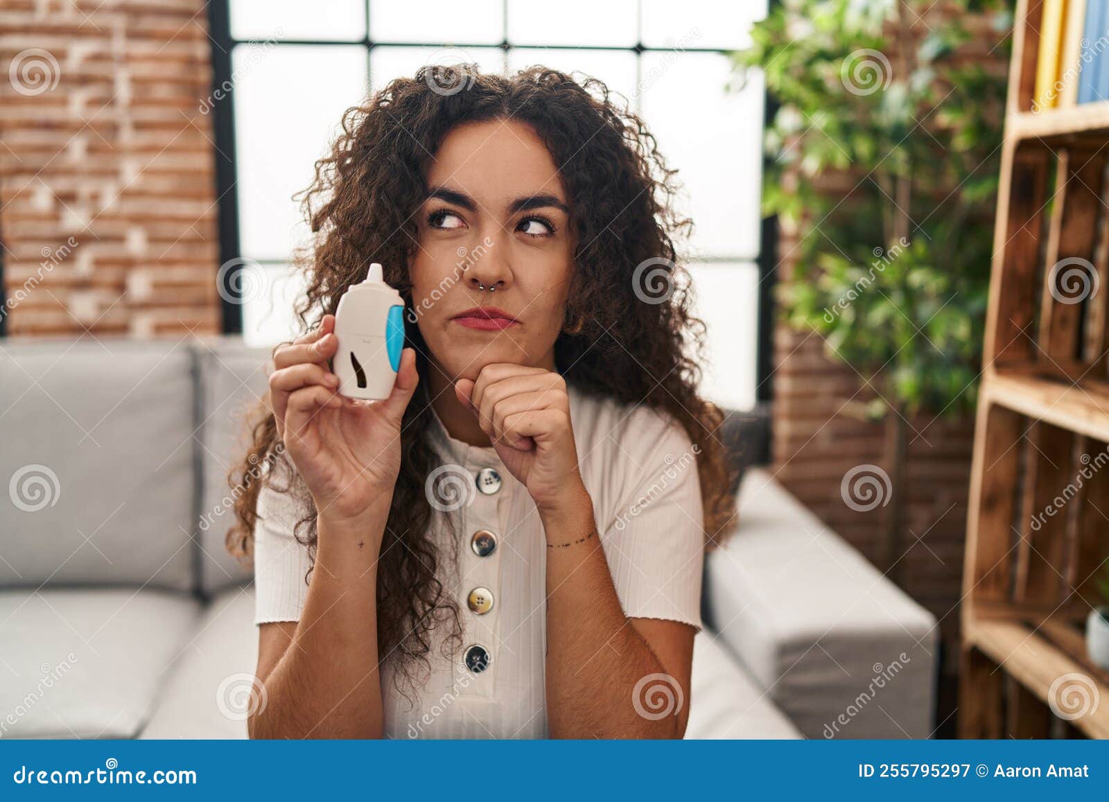 Young Hispanic Woman Using Glucose Meter Serious Face Thinking about ...