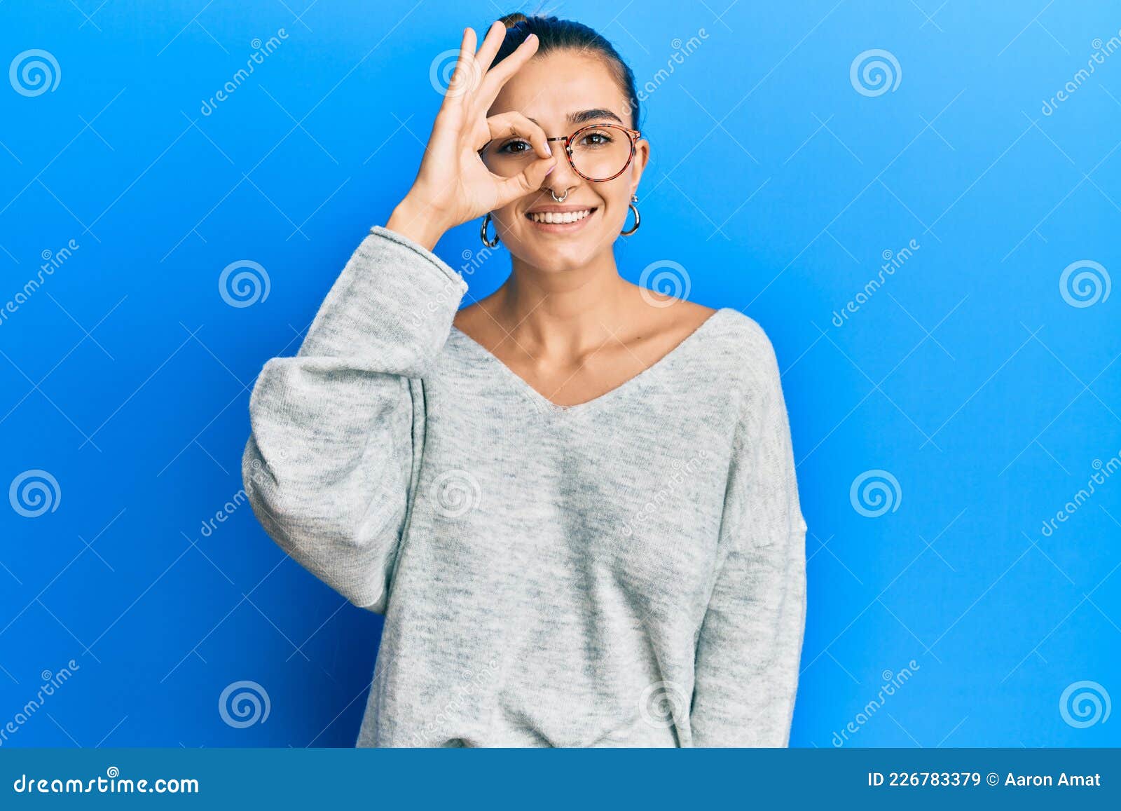 Young Hispanic Woman Wearing Casual Clothes Doing Ok Gesture With Hand