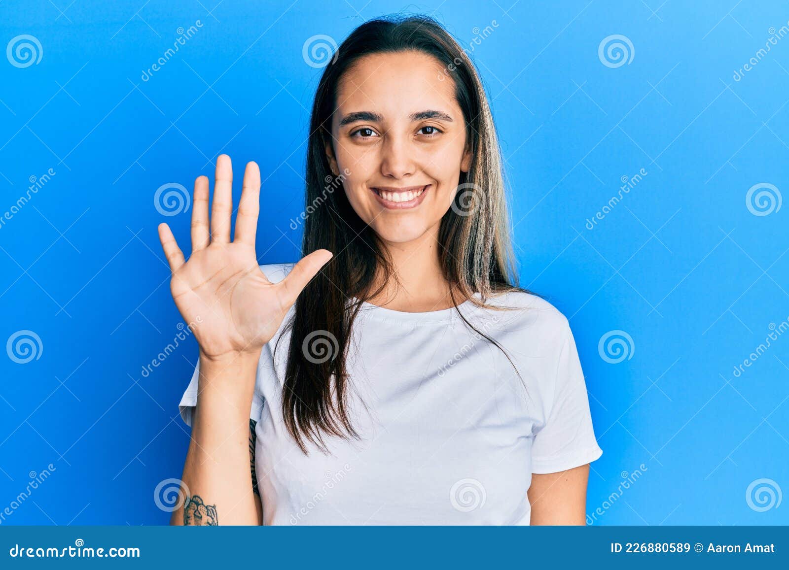 Young Hispanic Woman Wearing Casual White T Shirt Showing And Pointing