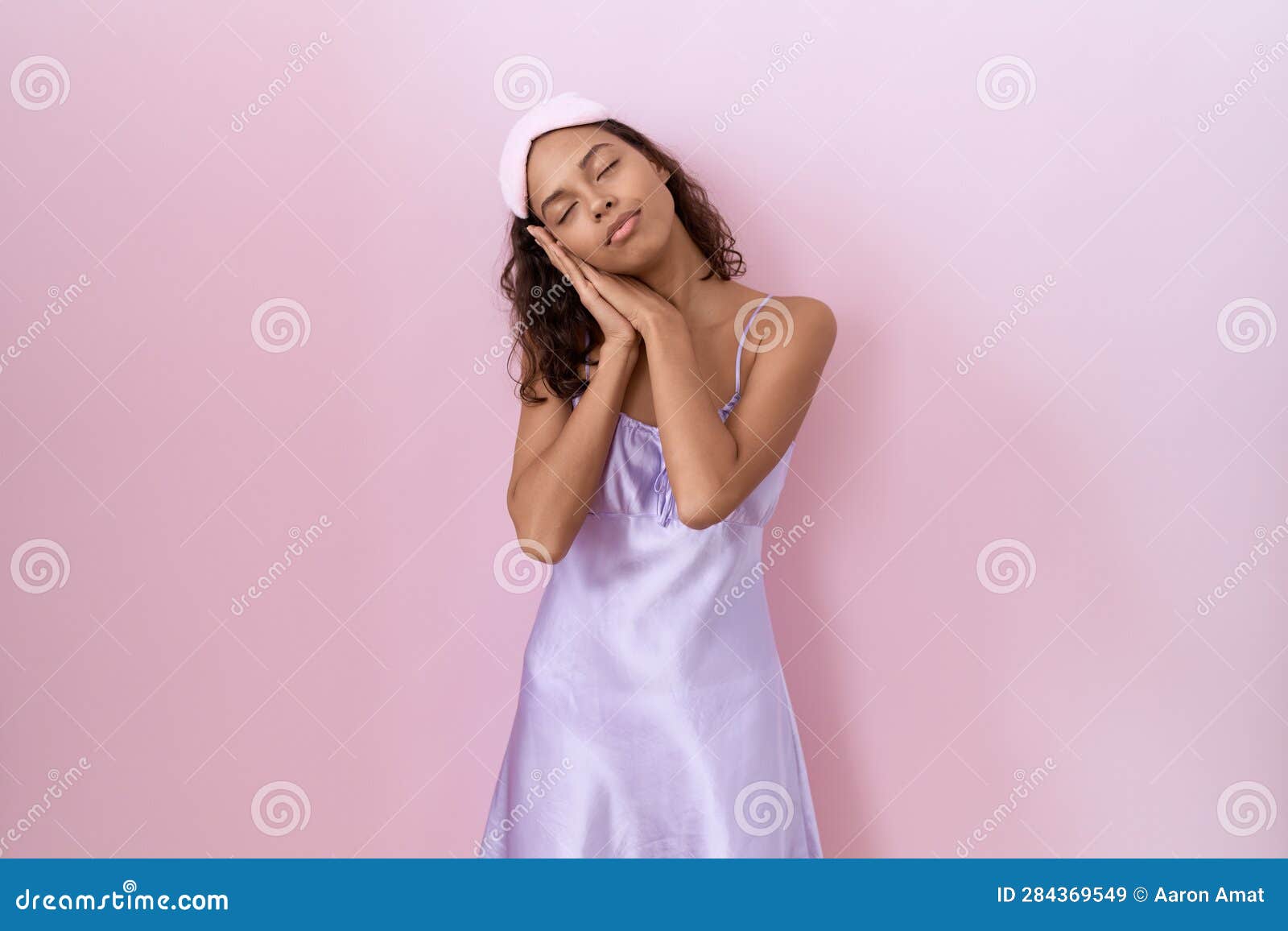 Young Hispanic Woman Wearing Sleep Mask And Nightgown Sleeping Tired