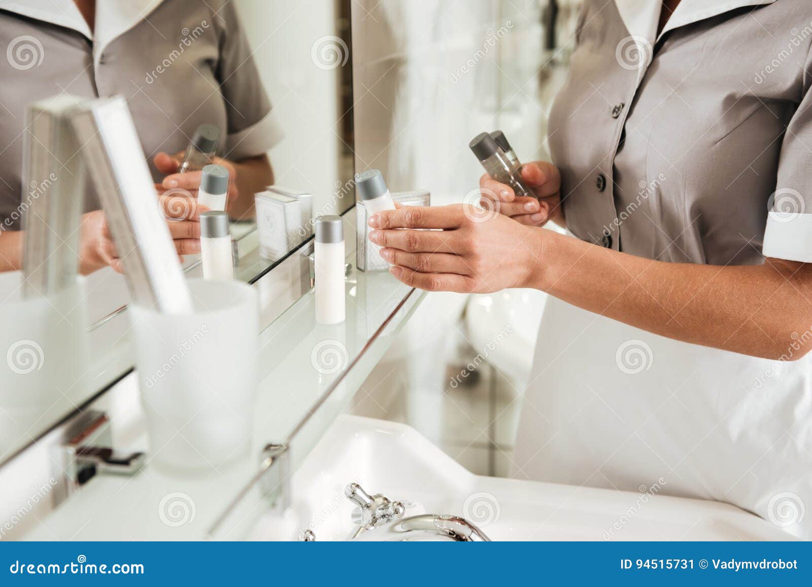 Young Hotel Maid Putting Bath Accessories in a Bathroom Stock Image ...