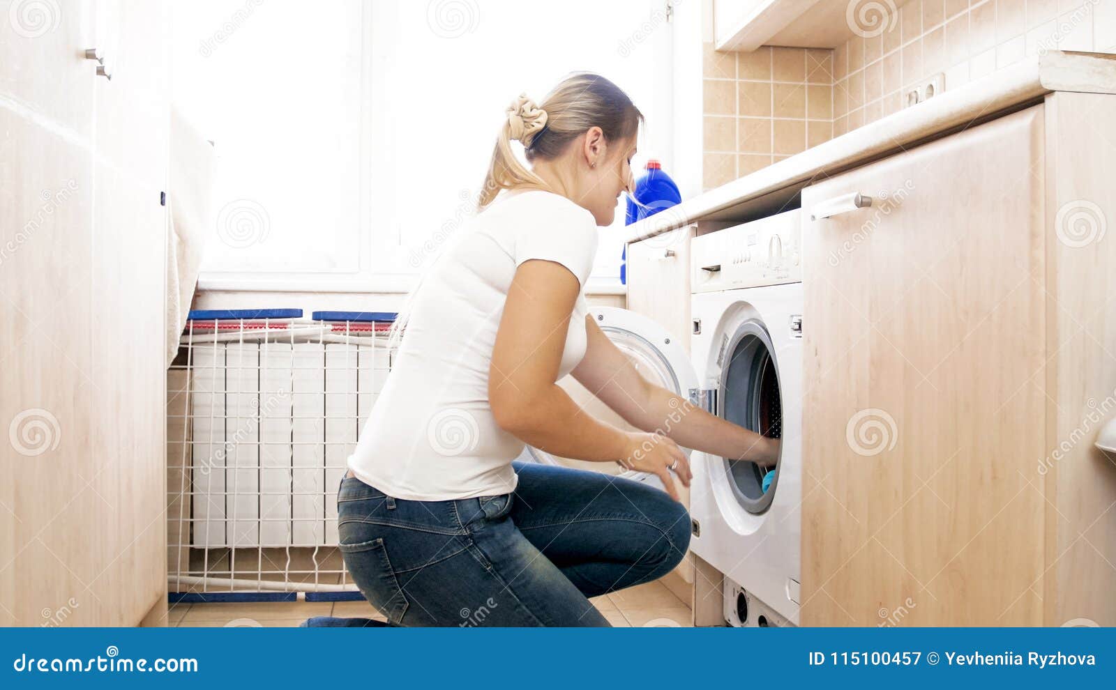 Young Housewife Loading Clothes in Washing Machine Stock Image - Image ...