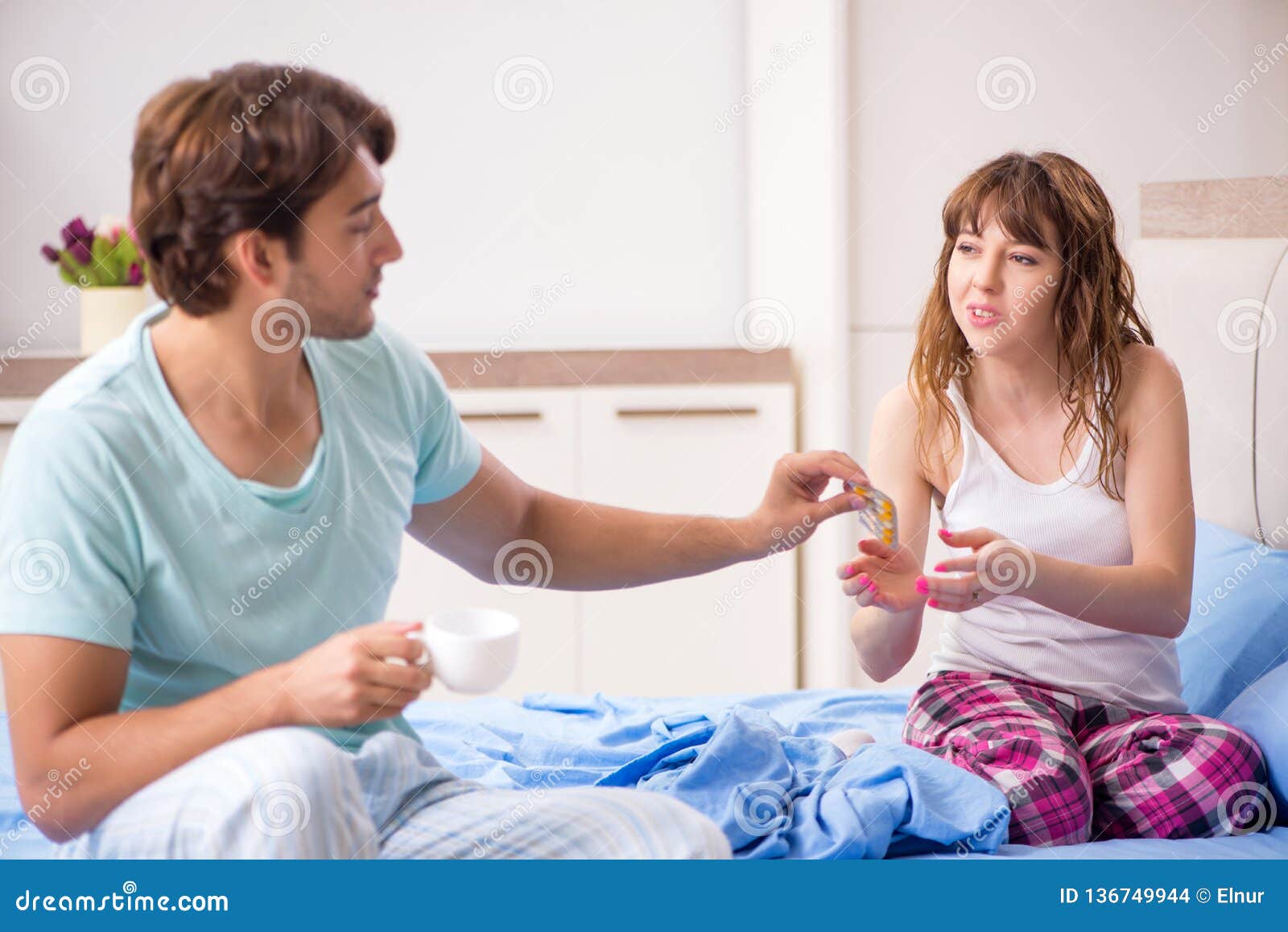 The Young Husband Looking after Sick Wife in the Bedroom Stock Photo ...