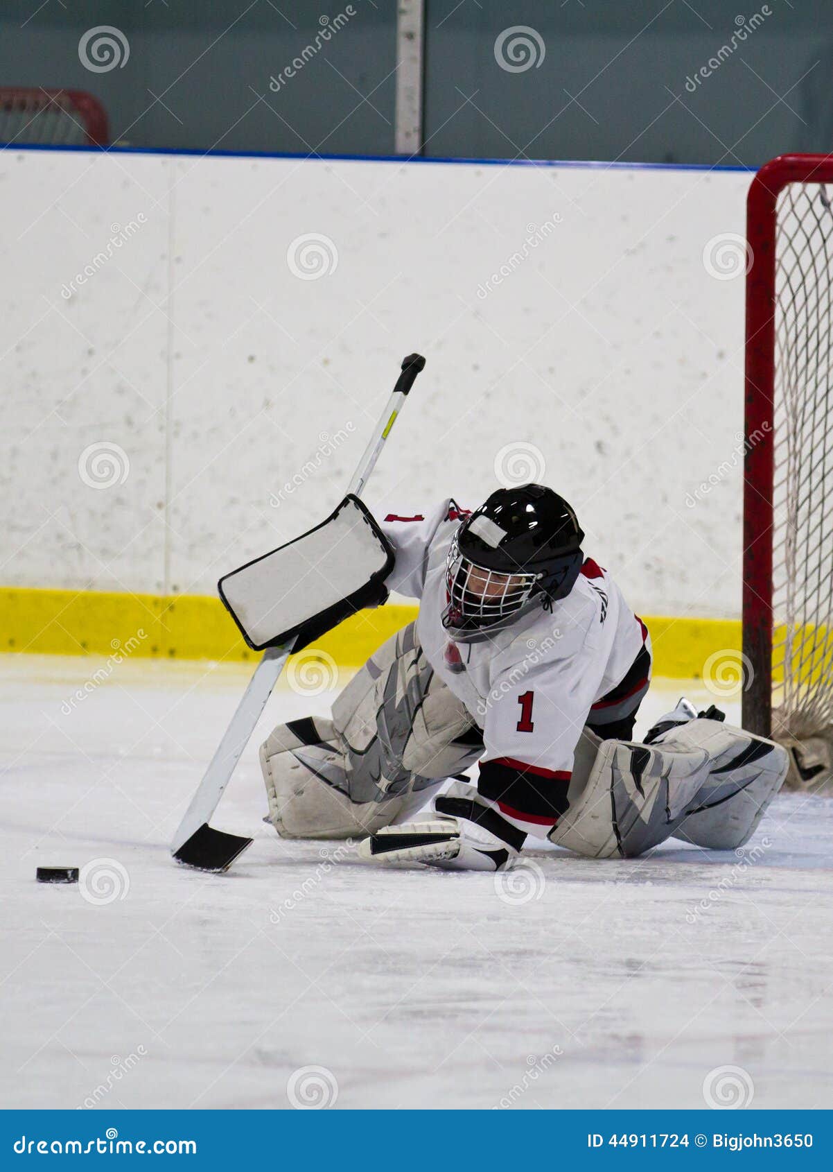 Young Ice Hockey Goaltender Making a Save Stock Photo - Image of rink ...