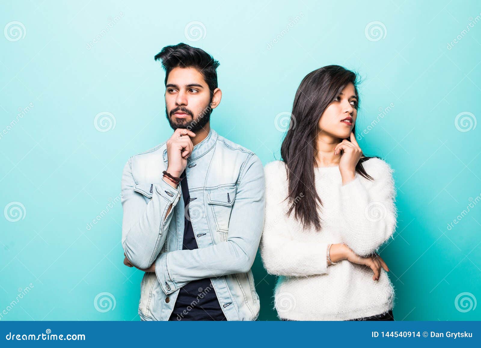 Young Indian Couple Thinking Standing Isolated on Green Background ...