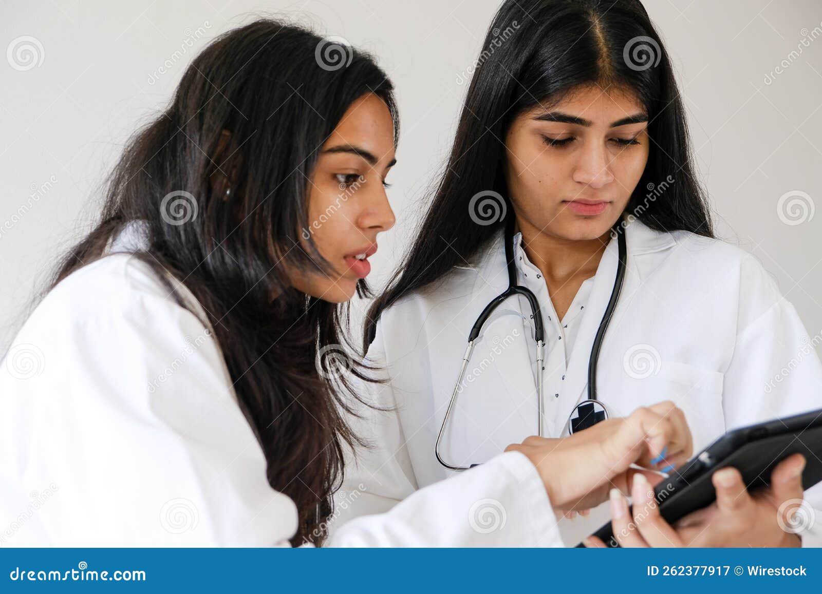 Young Indian Female Doctors in Uniforms Having a Discussion Stock Image ...