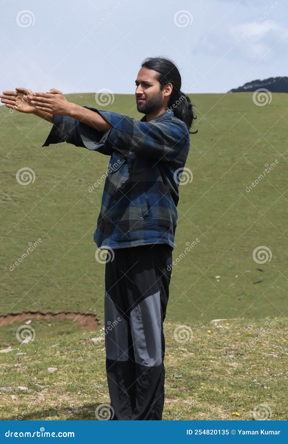 A Young Indian Guy Warm Up His Body with Doing Front Arm Raise Exercise ...
