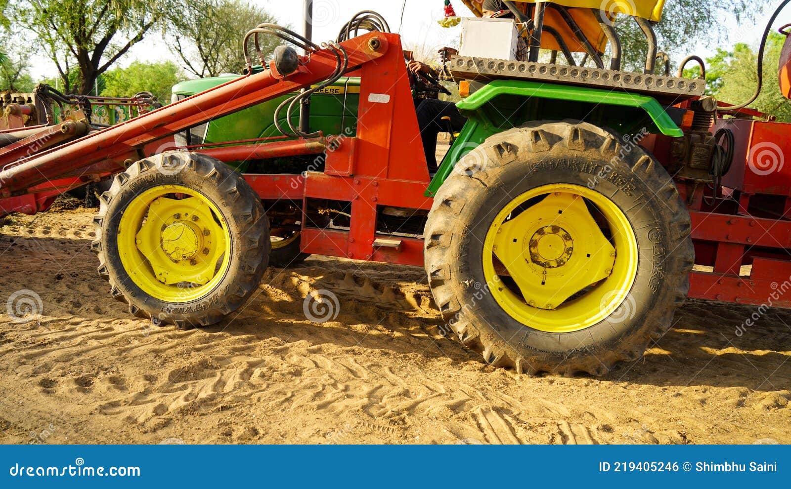 Young Indian Man Operating a Heavy Tractor with Loder . Farmer Fill ...