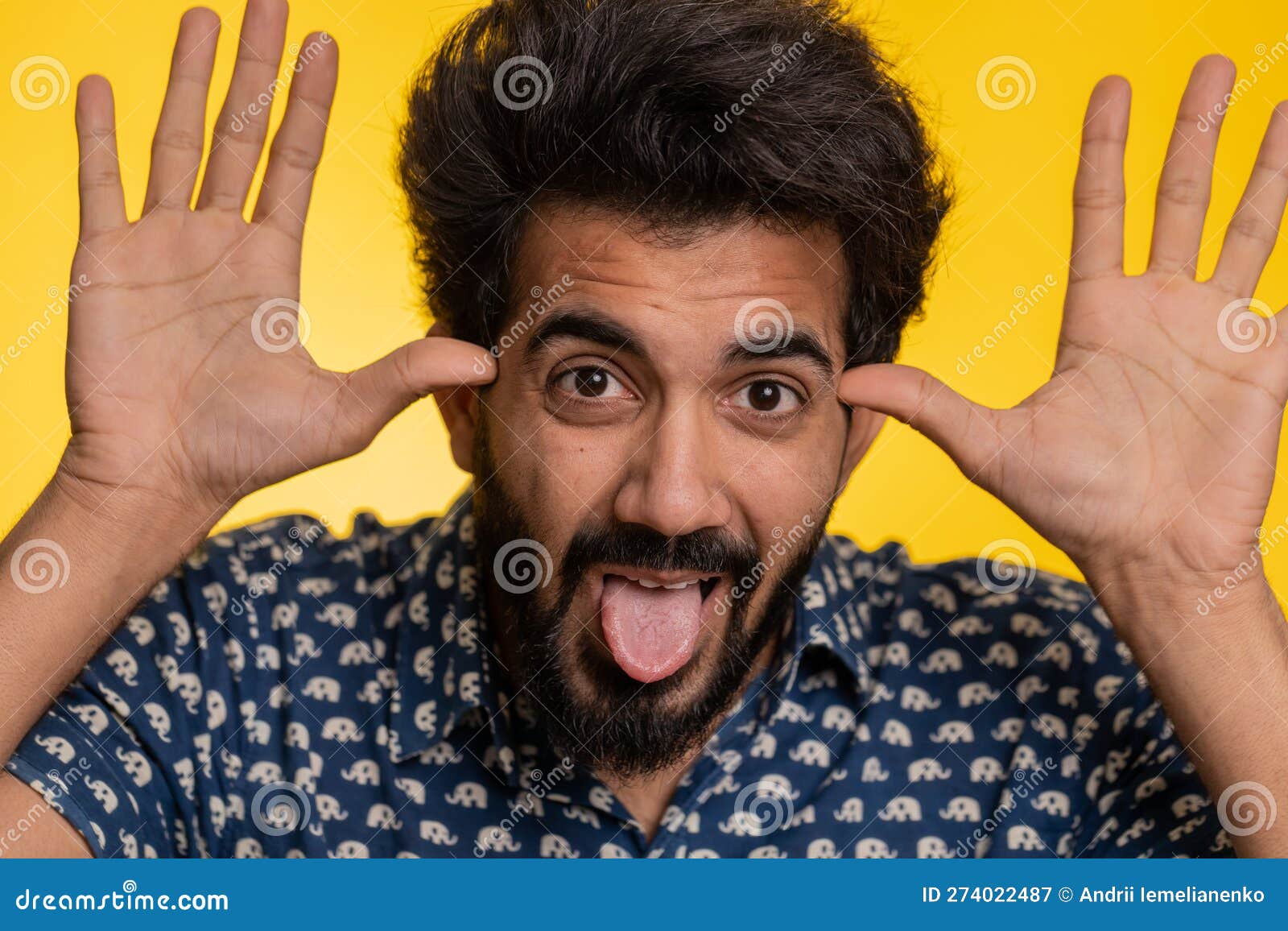Cheerful Funny Bully Indian Man Showing Tongue Making Silly Faces