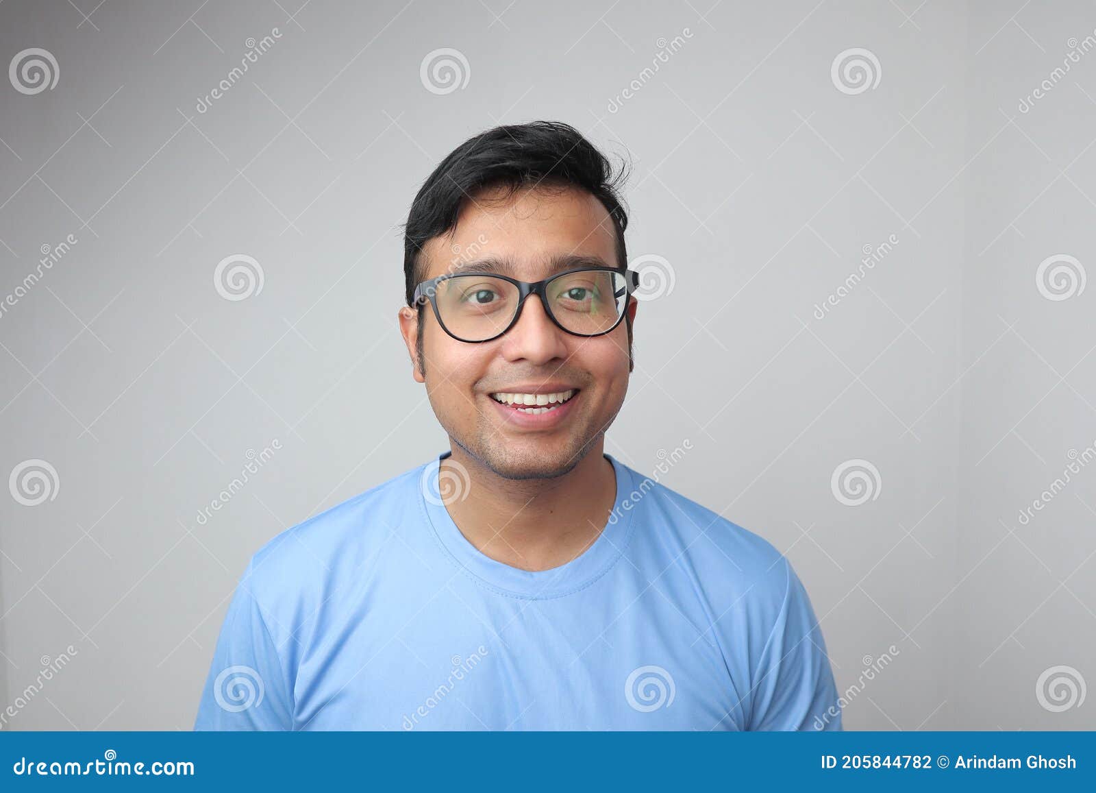 A Young Indian Man in Spectacles Looking Towards the Camera and Smiling ...