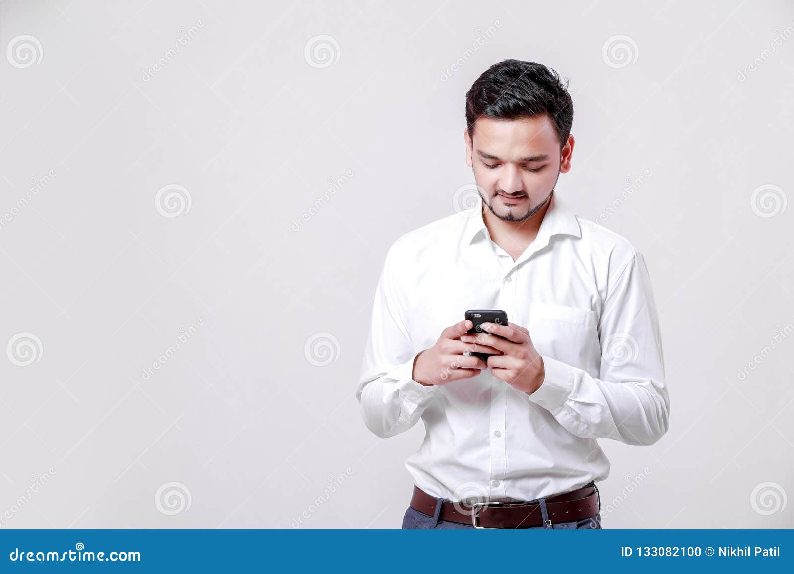 Young Indian Man Using Mobile Stock Photo - Image of person, building ...