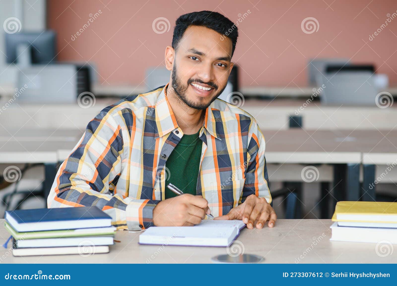 Young Indian Student Boy Reading Book Studying in College Library with ...