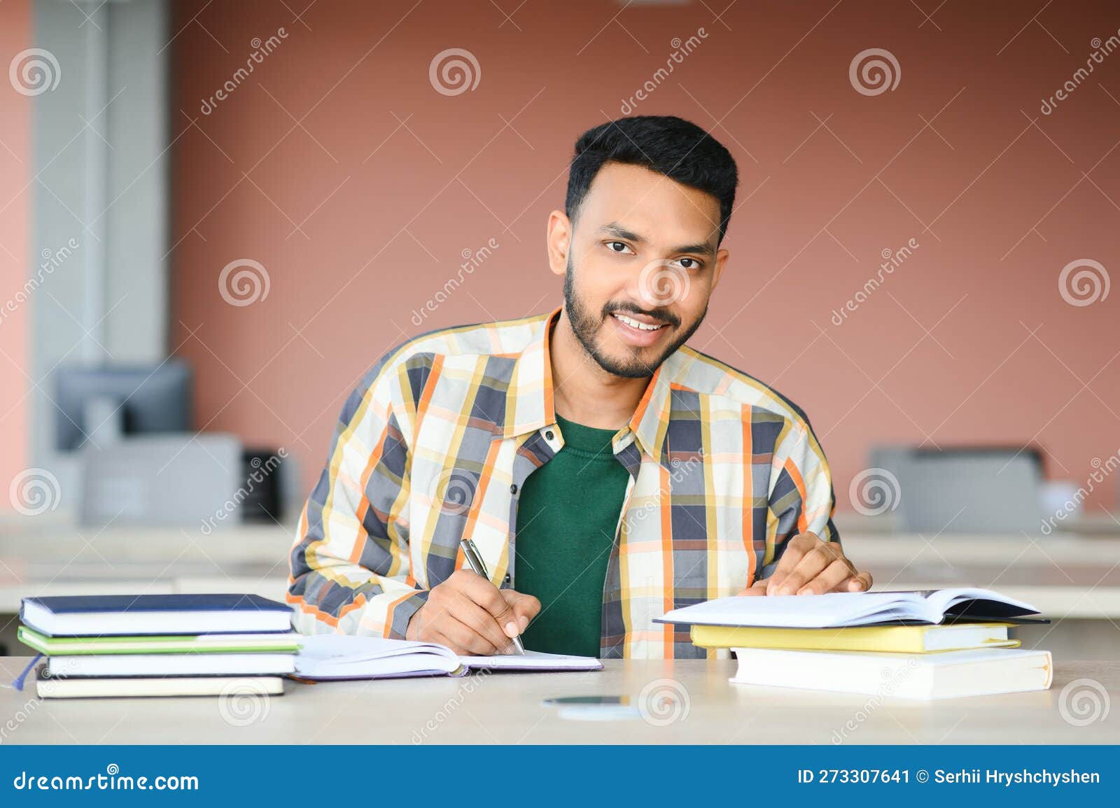 Young Indian Student Boy Reading Book Studying in College Library with ...