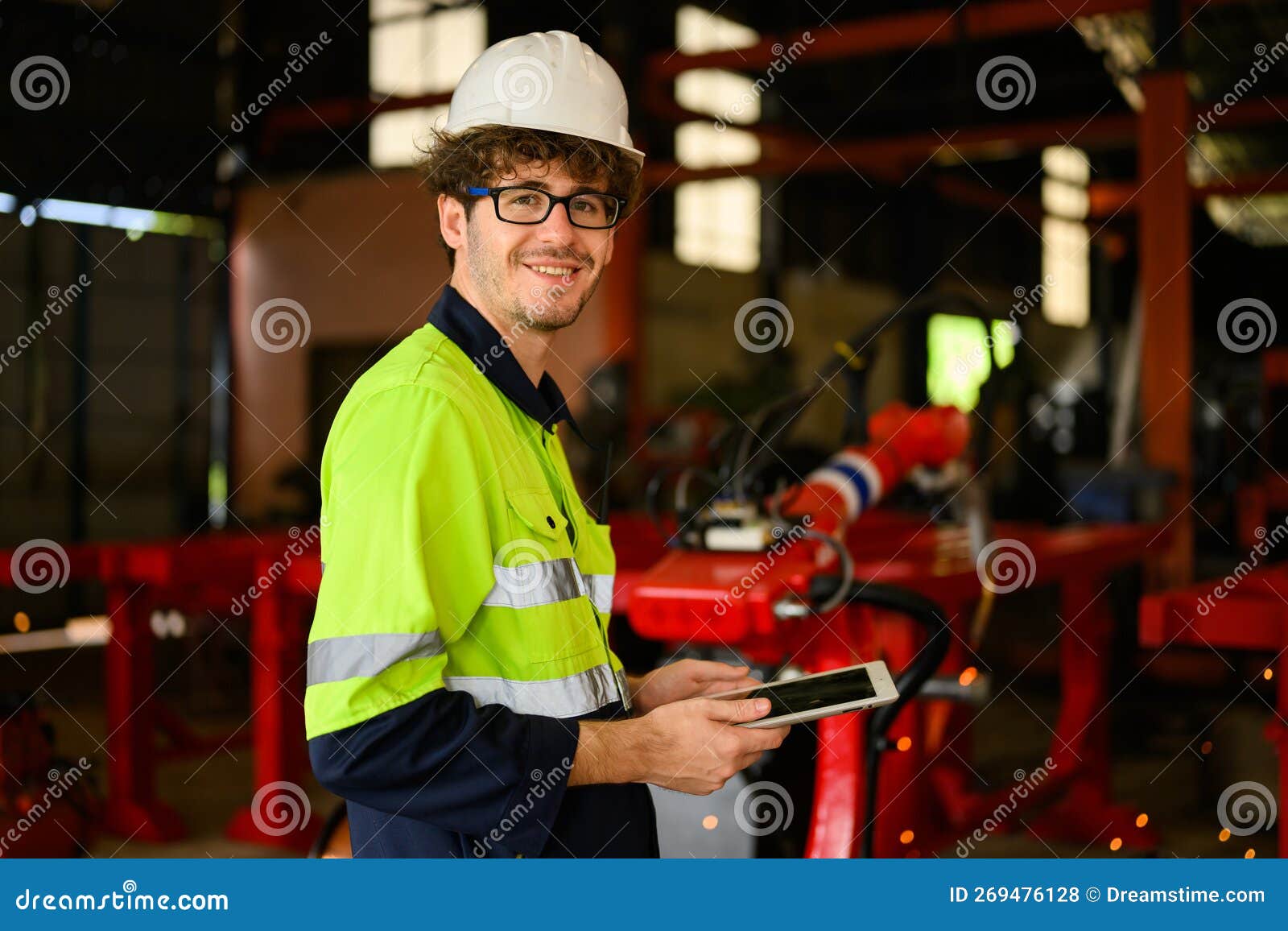 Young Industrial Engineer Holding Tablet Checking and Controlling ...