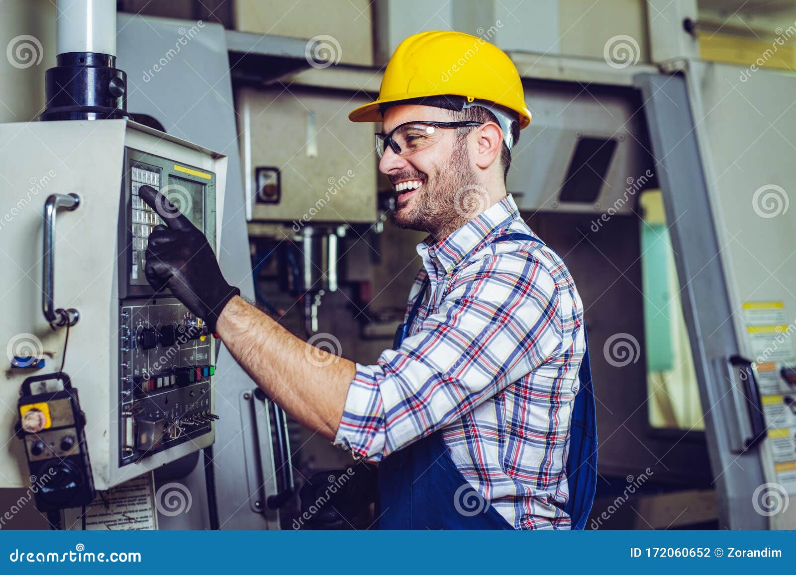 Industry Worker Entering Data in CNC Machine at Factory. Stock Photo ...