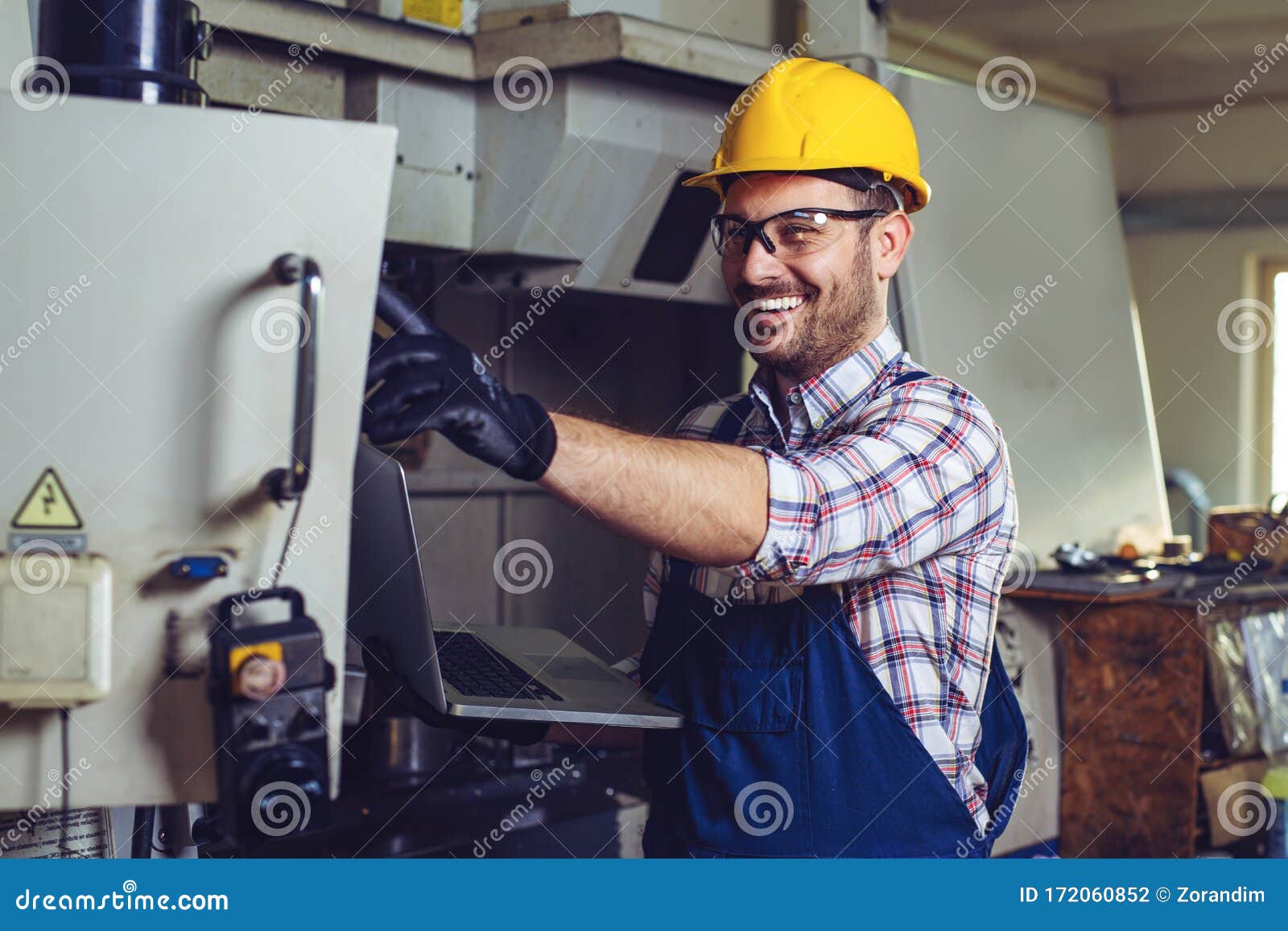 Industry Worker Entering Data in CNC Machine at Factory. Stock Photo ...
