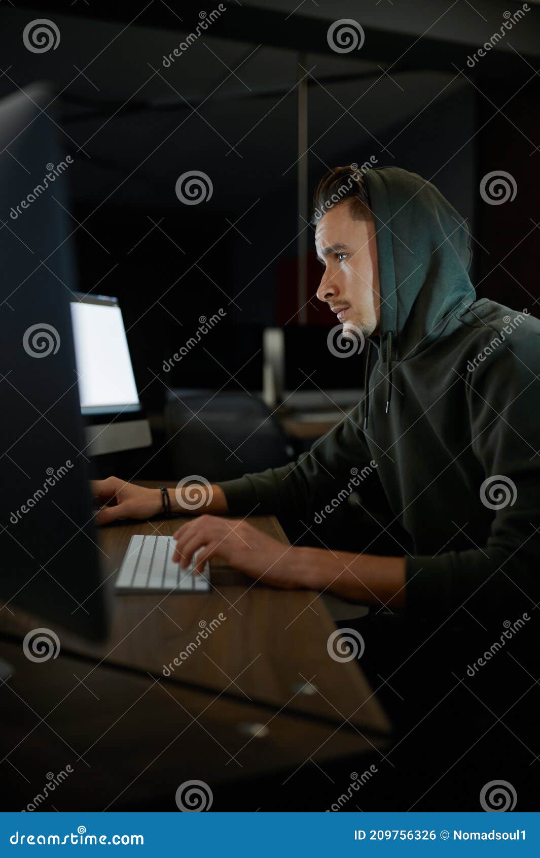 Young Internet Hacker in Hood Sitting at Monitors Stock Photo - Image ...