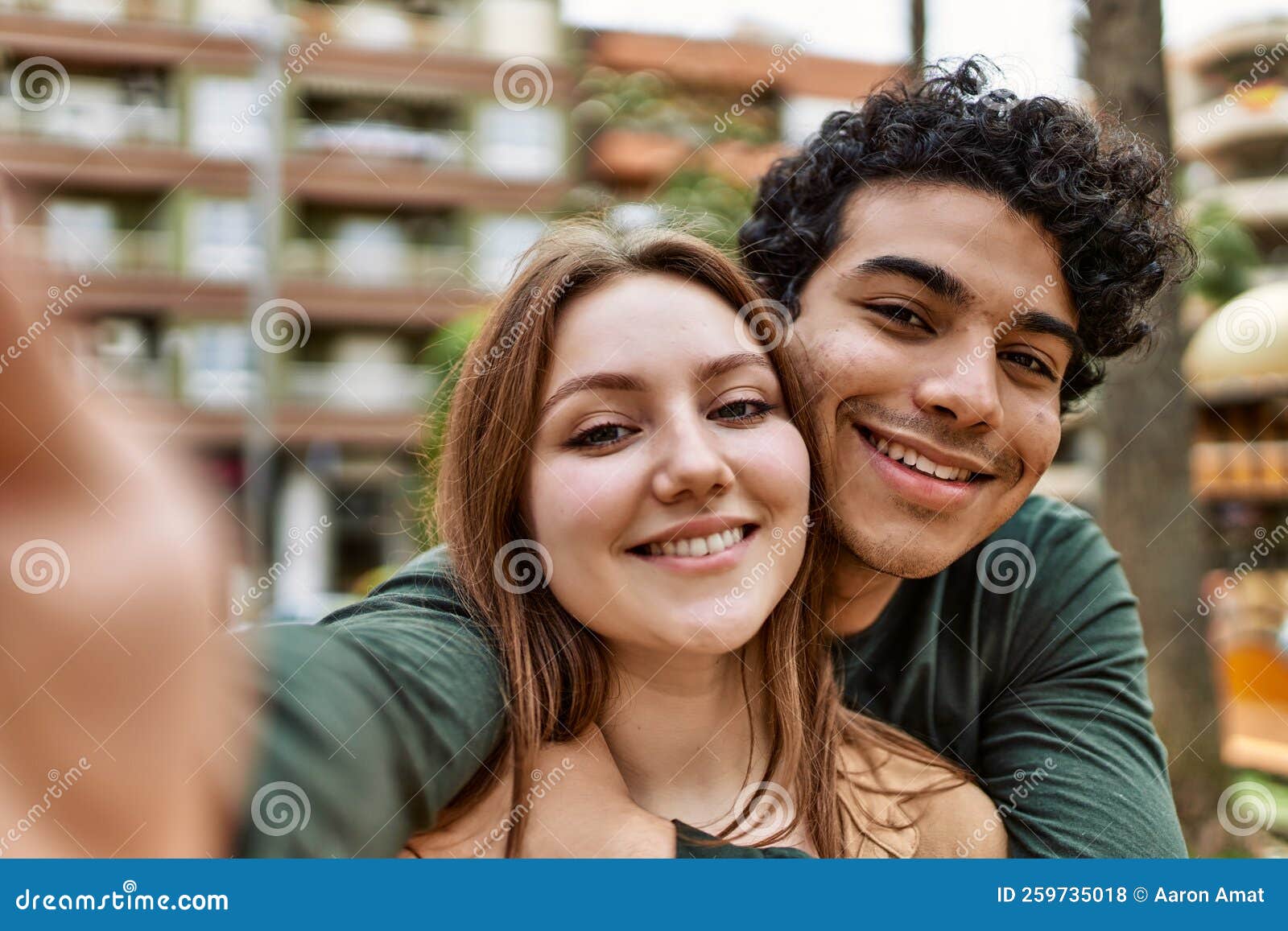 Young Interracial Couple Smiling Happy And Hugging Make Selfie By The
