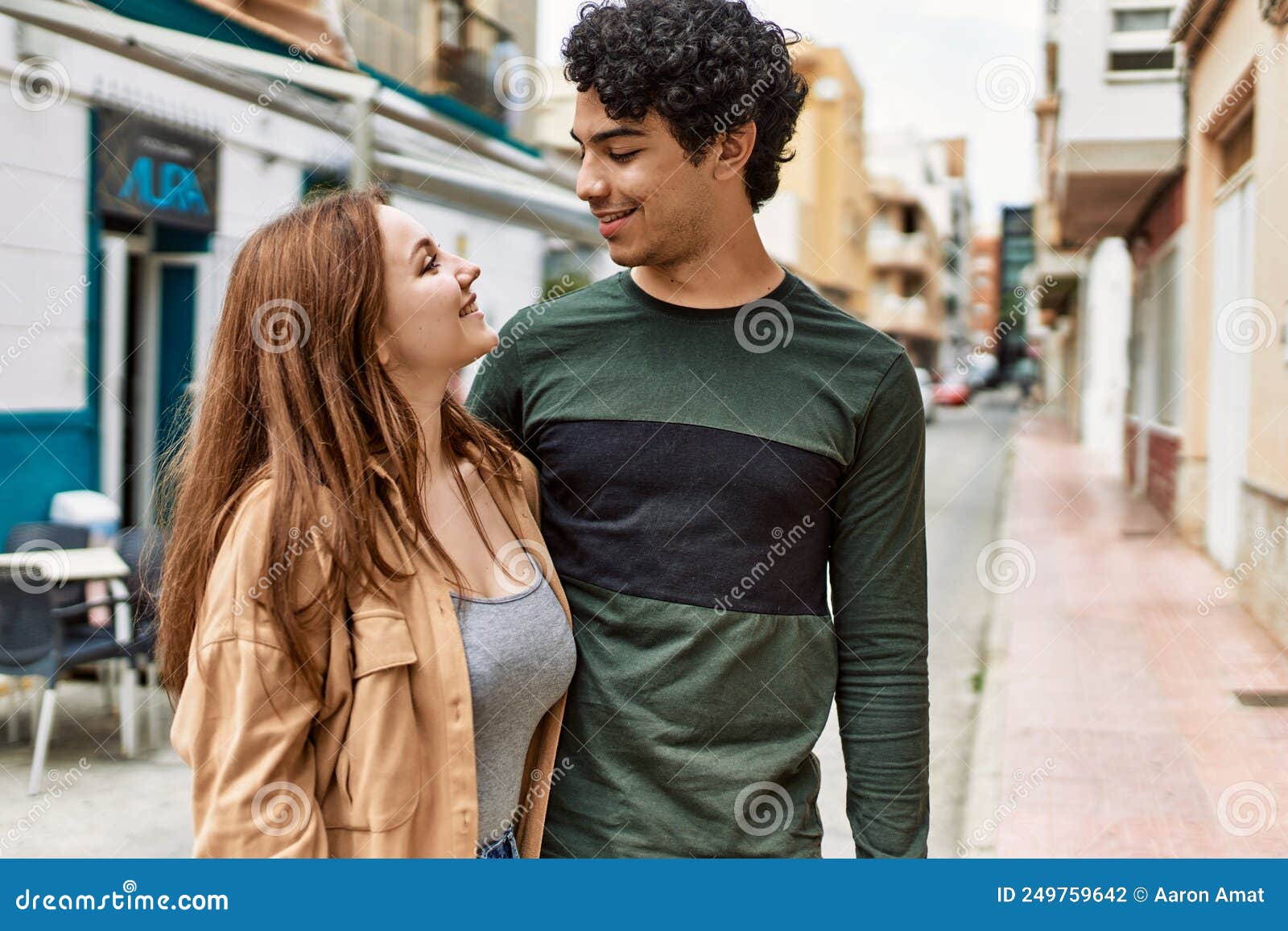 Young Interracial Couple Smiling Happy And Hugging Standing At The City