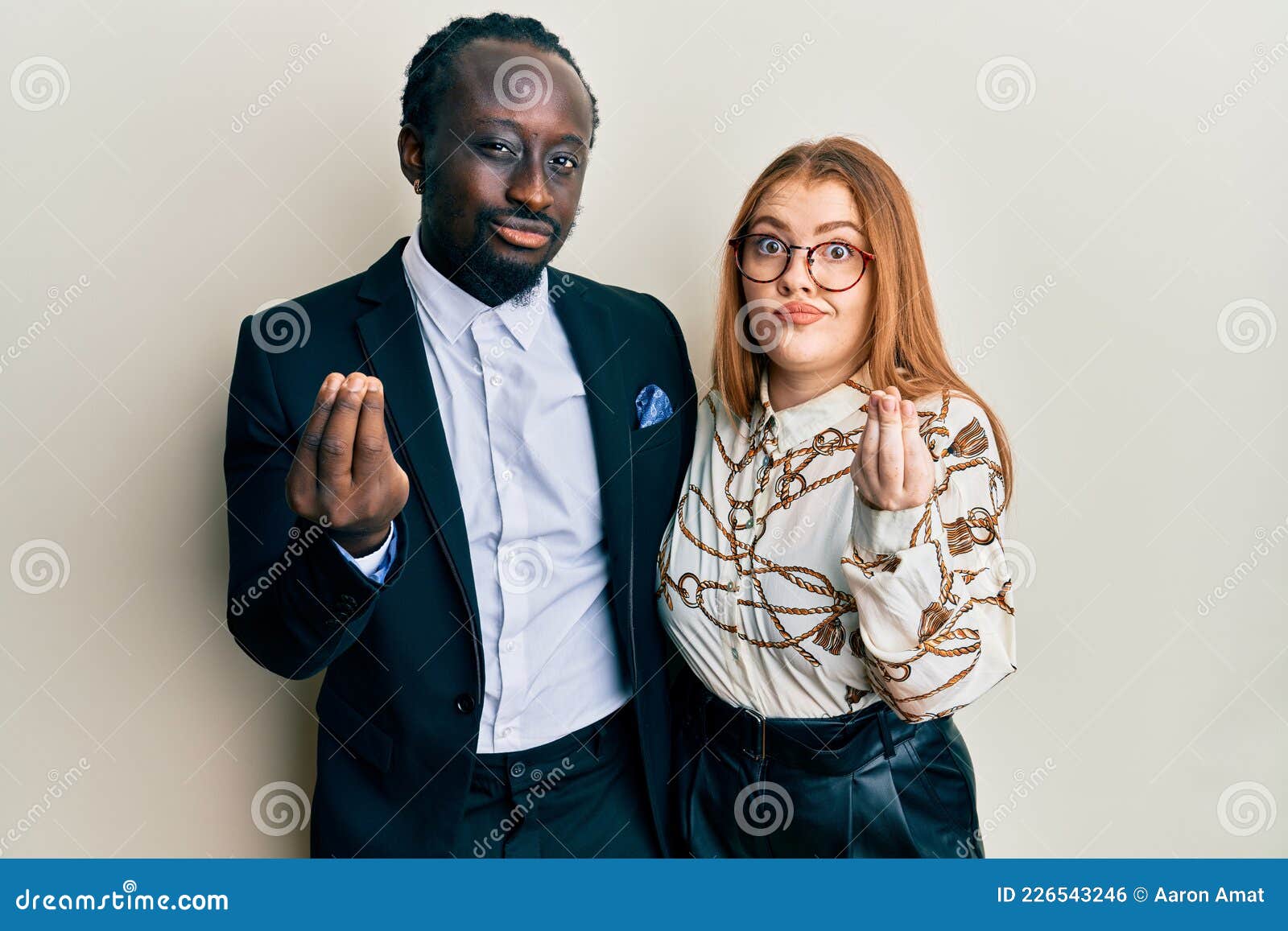 Young Interracial Couple Wearing Business And Elegant Clothes Doing