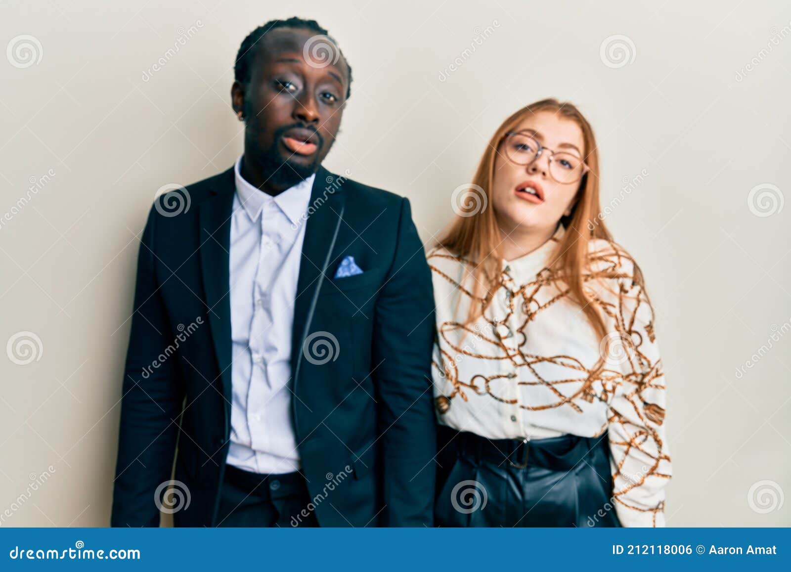 Young Interracial Couple Wearing Business And Elegant Clothes Looking