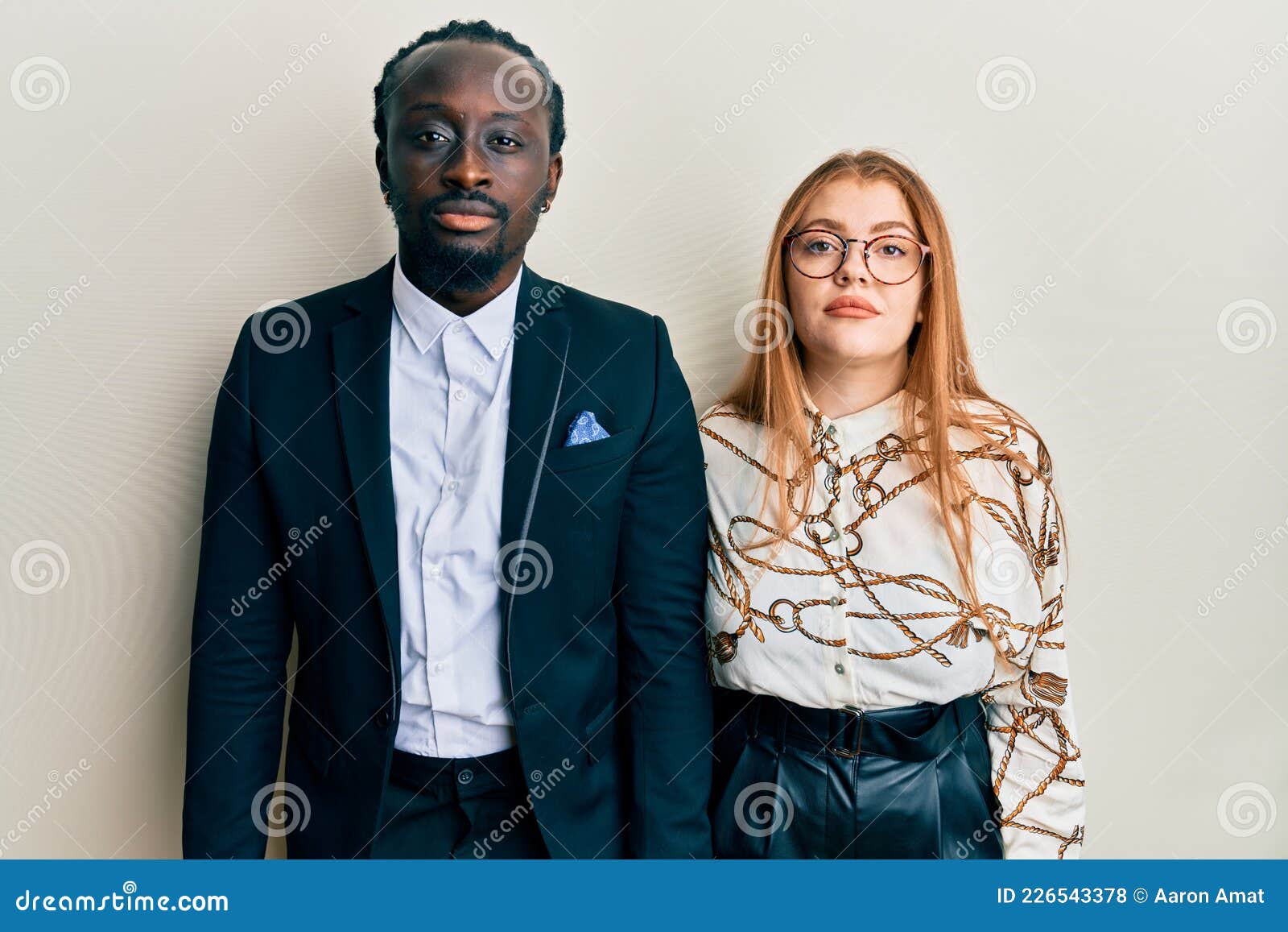 Young Interracial Couple Wearing Business And Elegant Clothes Relaxed
