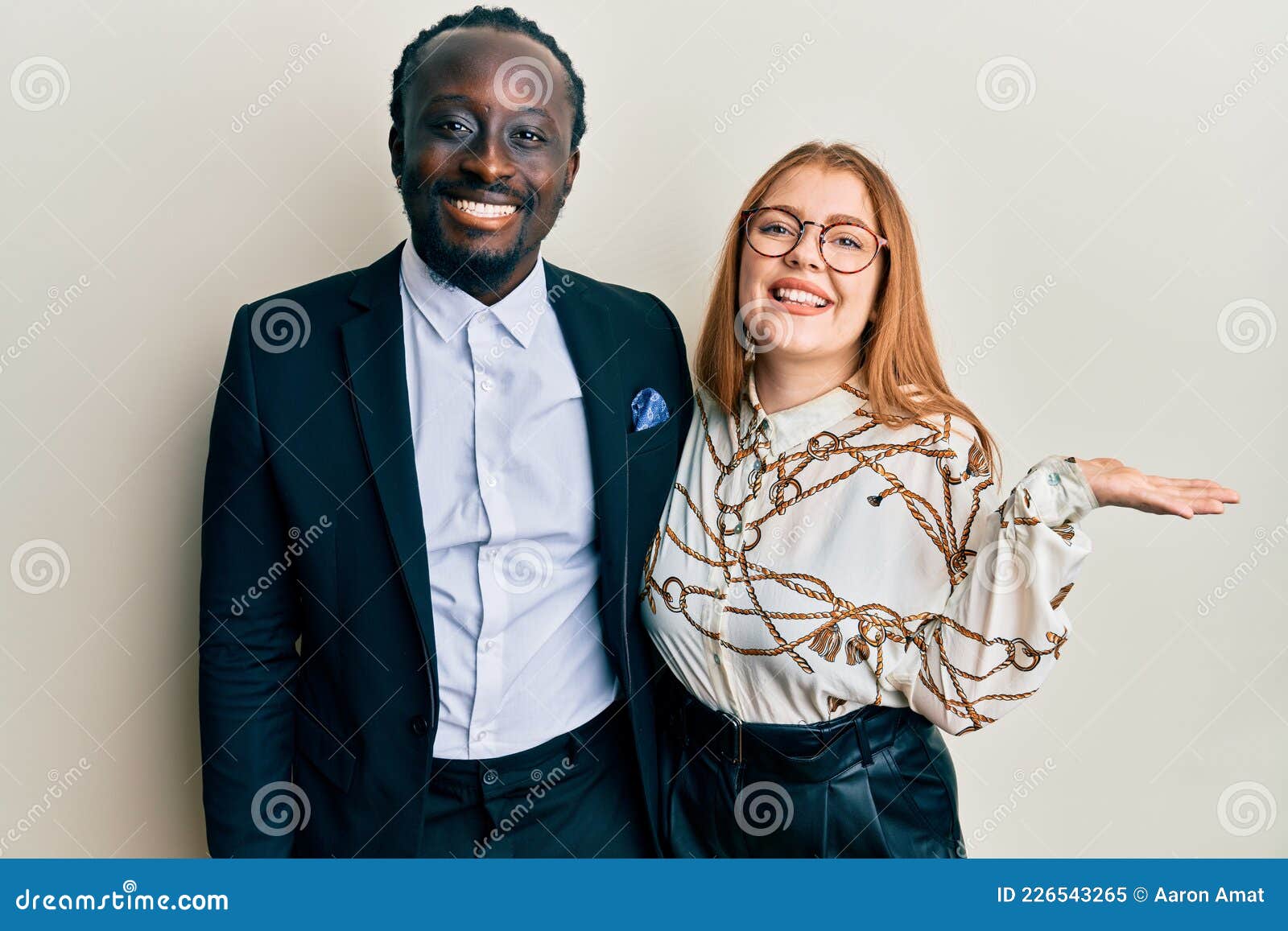 Young Interracial Couple Wearing Business And Elegant Clothes Smiling