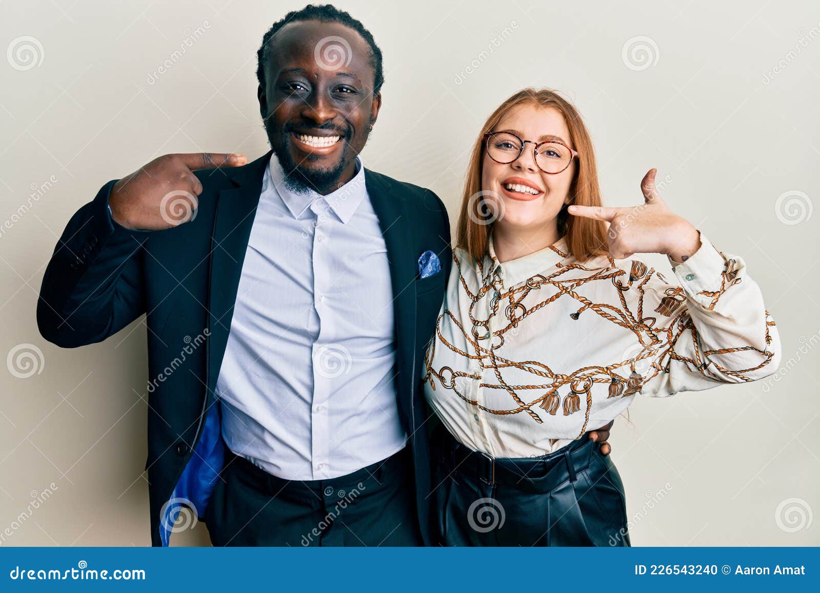 Young Interracial Couple Wearing Business And Elegant Clothes Smiling