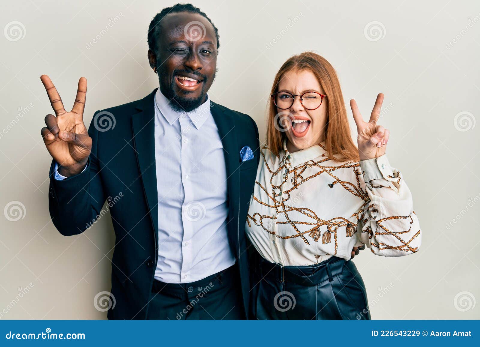 Young Interracial Couple Wearing Business And Elegant Clothes Smiling