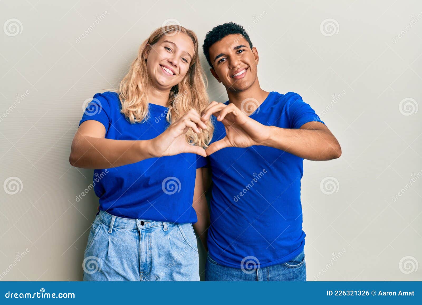 Young Interracial Couple Wearing Casual Clothes Smiling In Love Doing