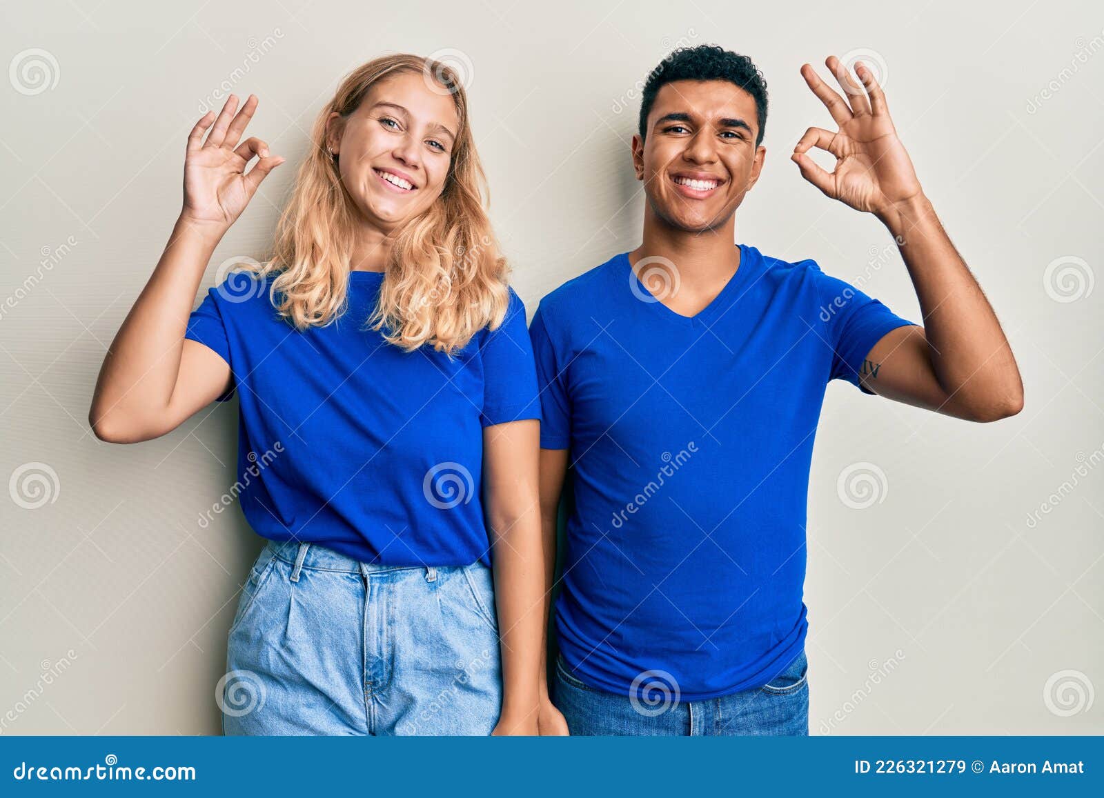 Young Interracial Couple Wearing Casual Clothes Smiling Positive Doing