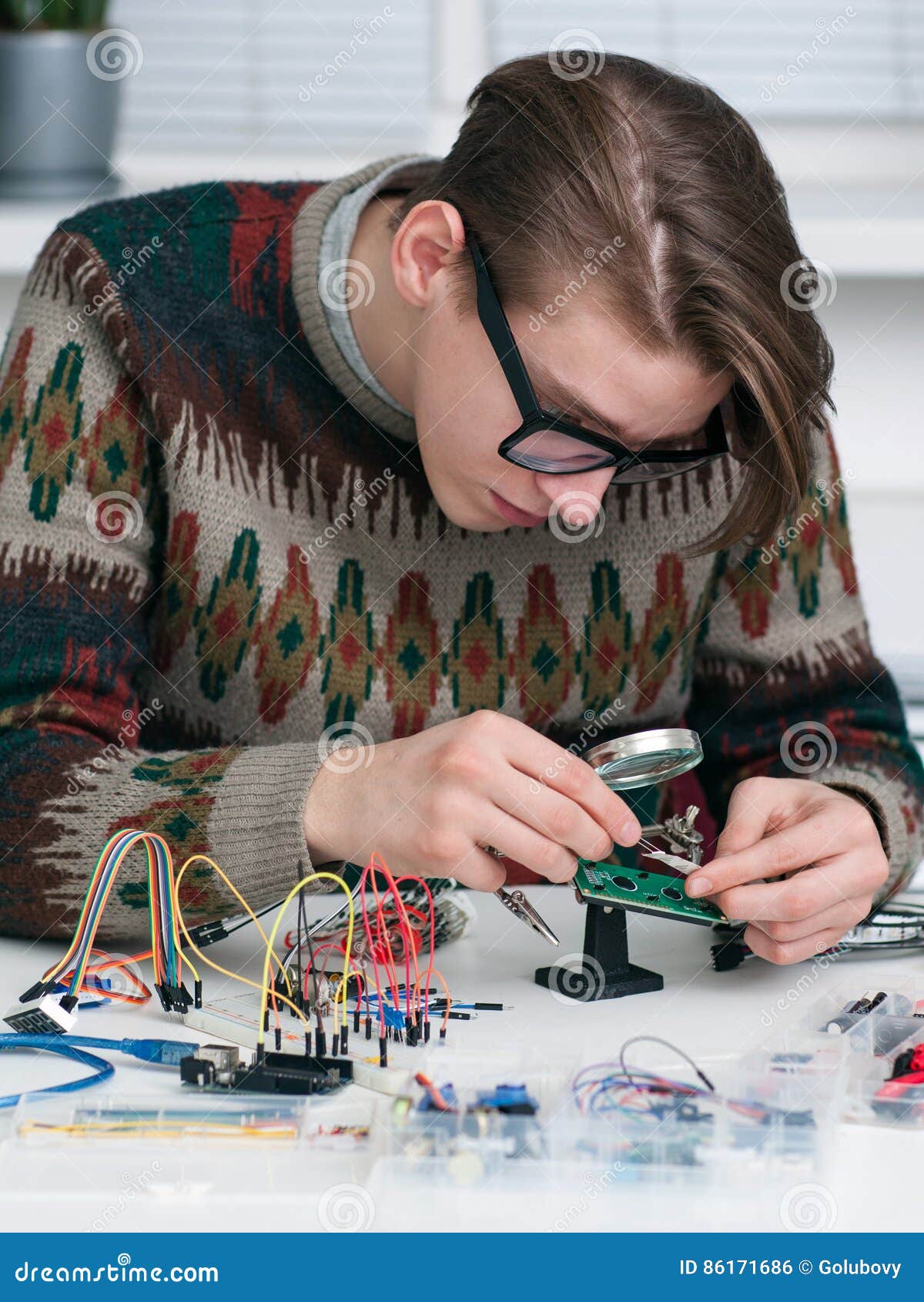 Young Inventor Examing Electronic Component Stock Photo - Image of ...