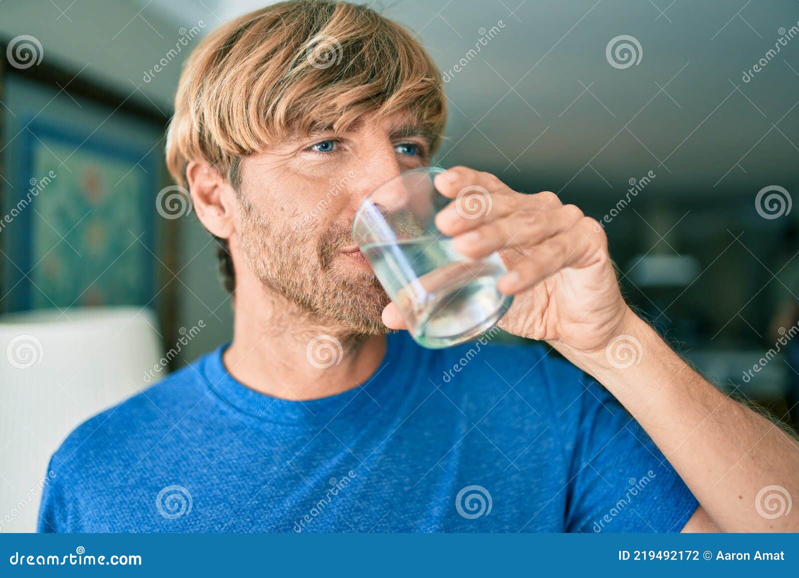 Young Irish Man Drinking Glass of Water Standing at Home Stock Photo ...