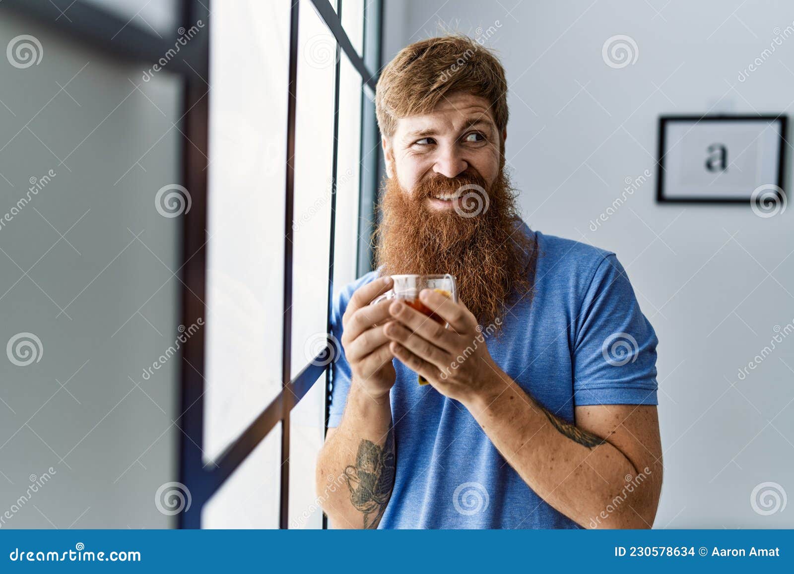 Young Irish Man Drinking Tea Standing by the Window at Home Stock Photo ...