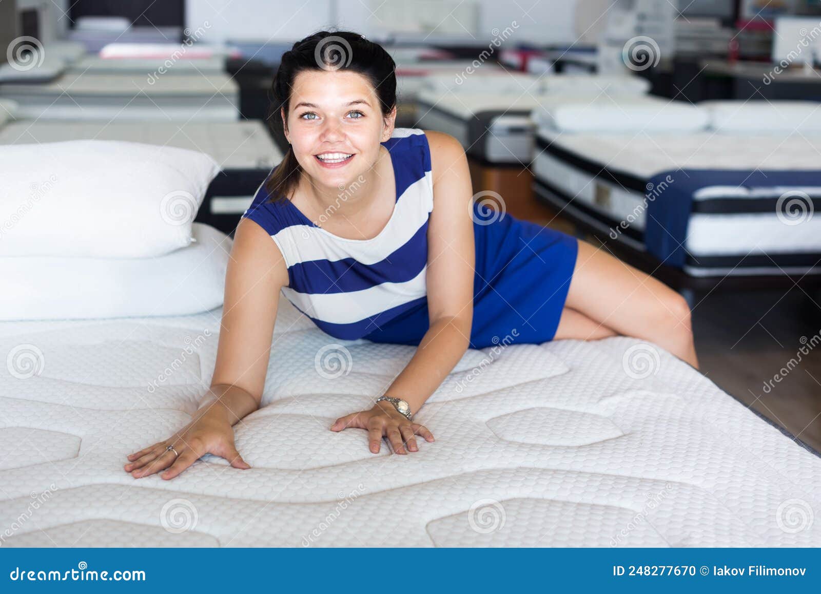 Woman is Lying on Bed and Testing Mattress in the Store. Stock Photo ...