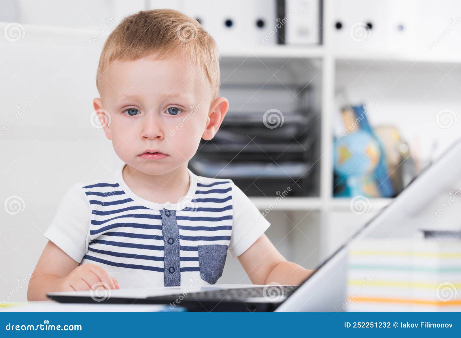 Young Kid is Surfing in Internet on Laptop Stock Photo - Image of ...