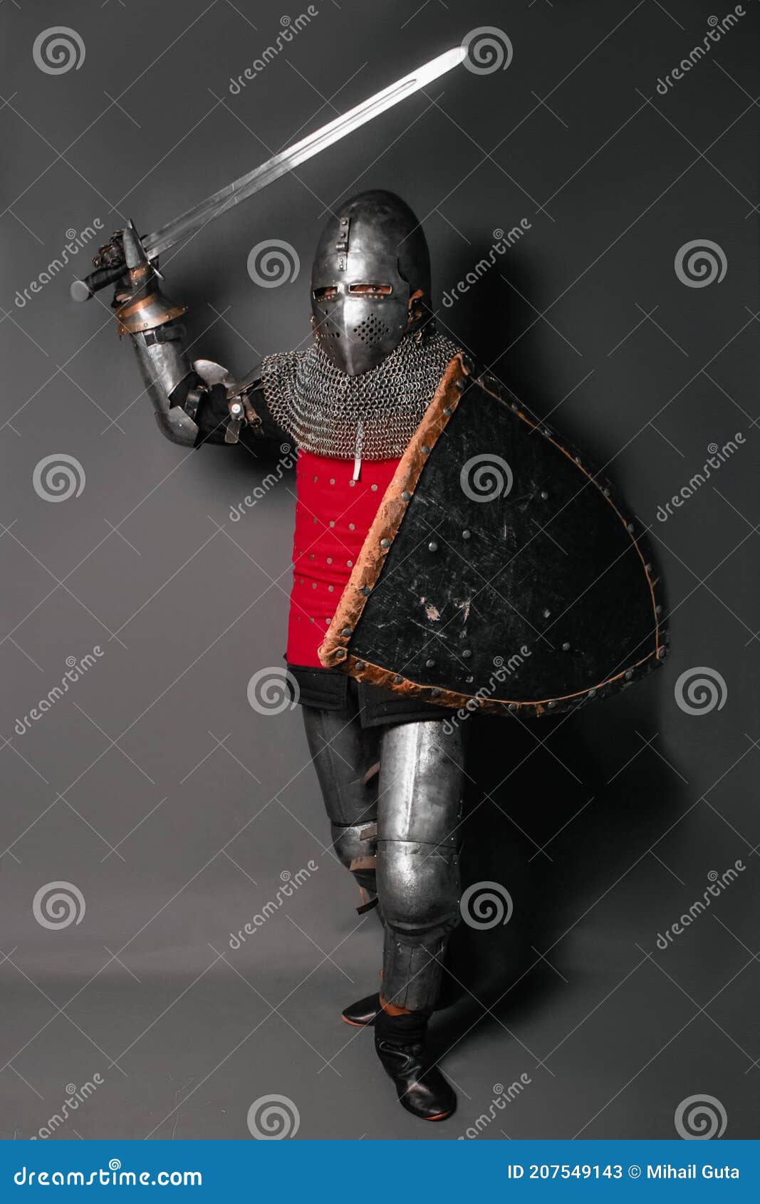 A Young Knight In Medieval Armor With A Weapon In His Hands Kneeled ...