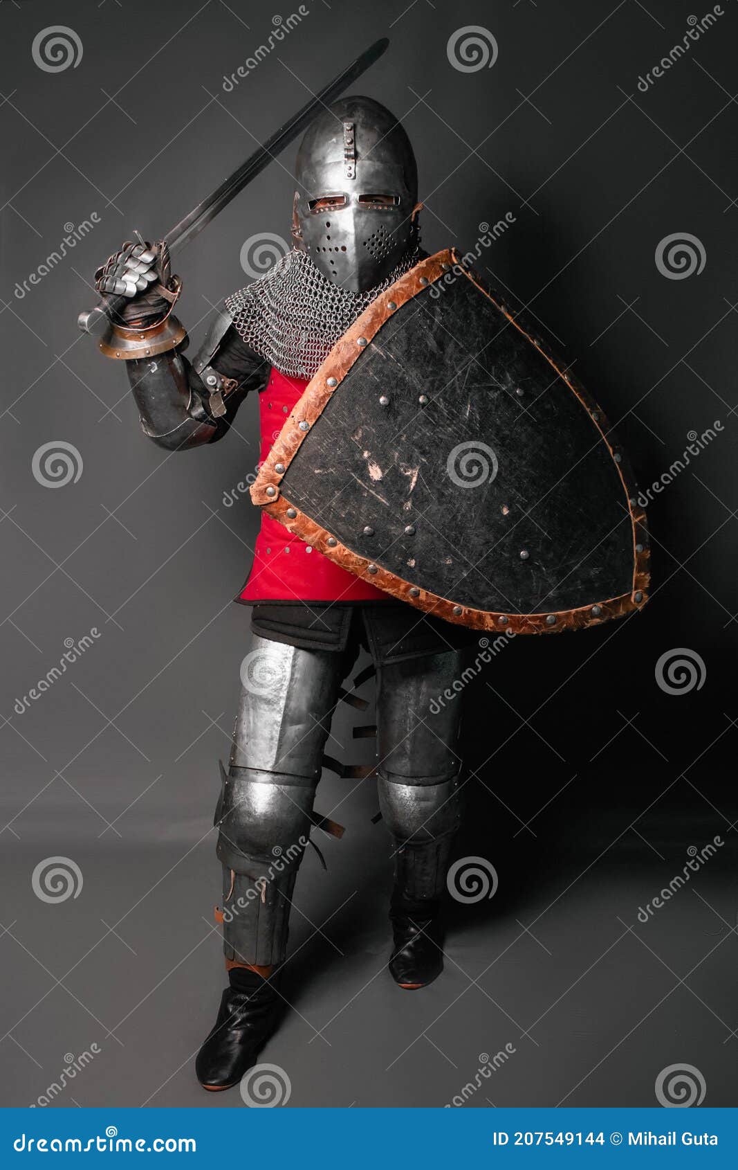 A Young Knight in Medieval Armor with a Weapon in His Hands Kneeled ...