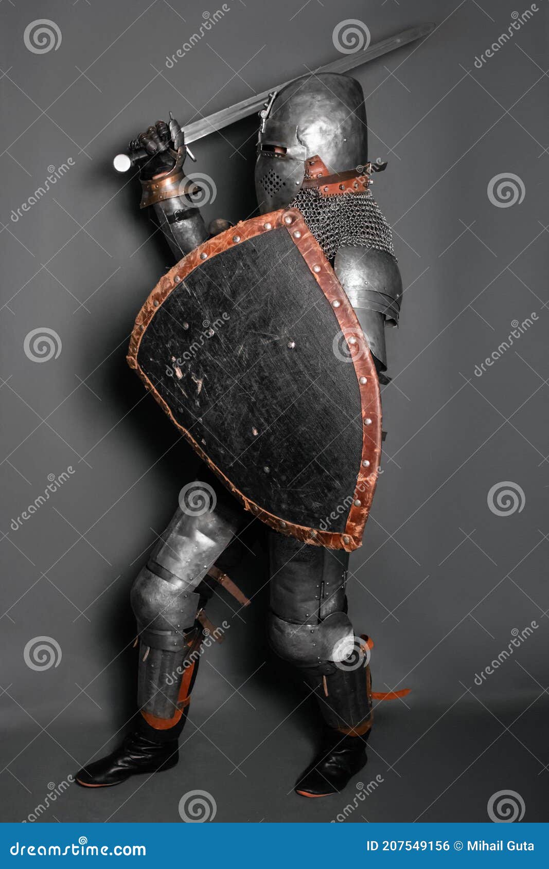 A Young Knight In Medieval Armor With A Weapon In His Hands Kneeled ...