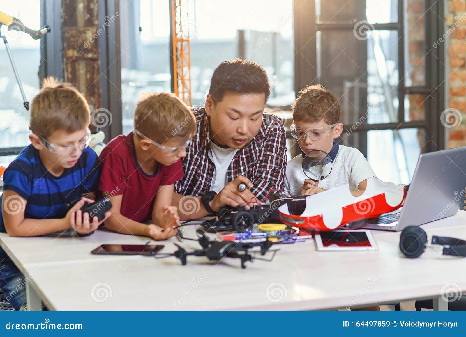 Young Korean Man Of Electronics Engineer With Young Children Using ...