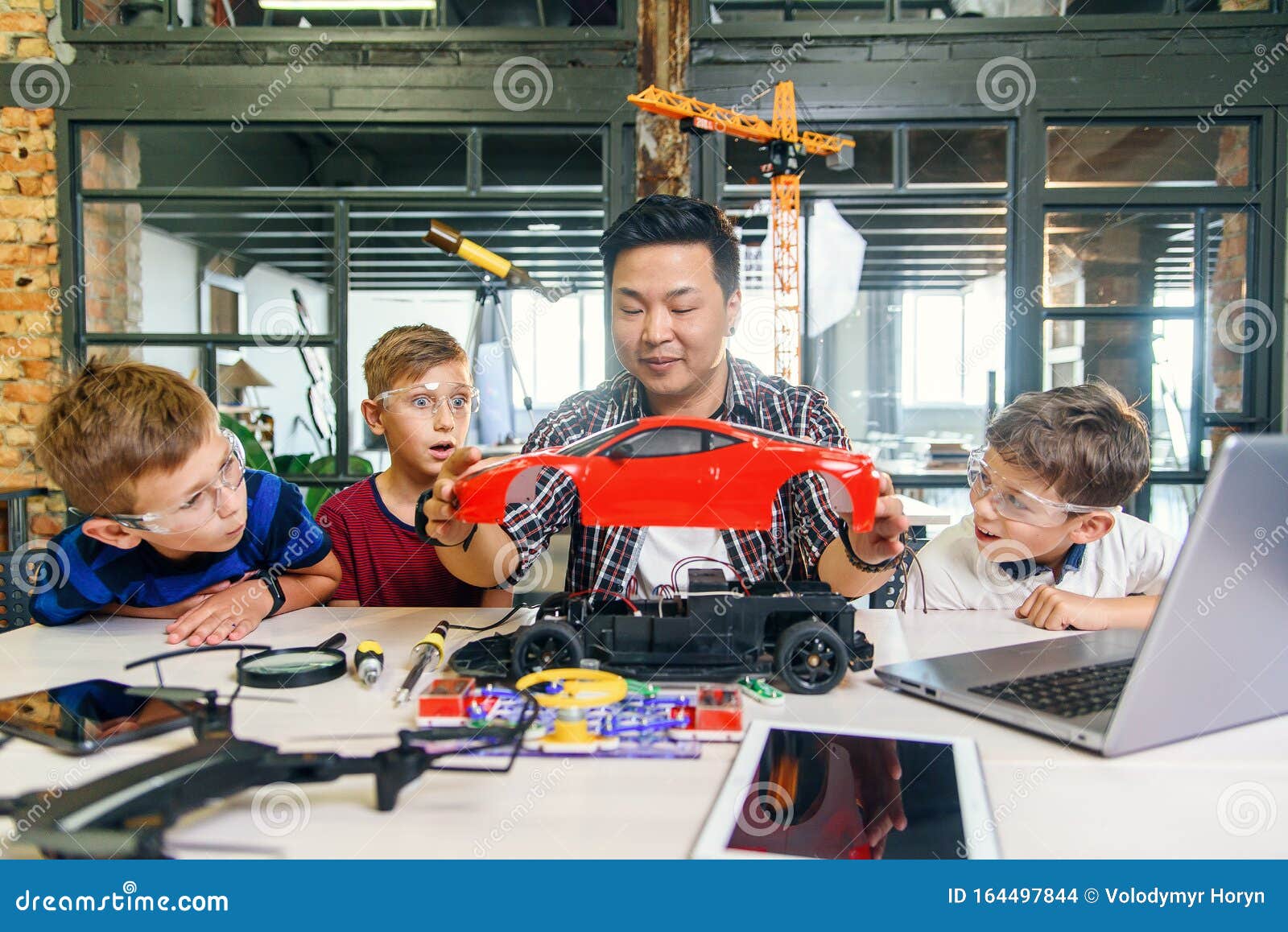 Young Korean Man of Electronics Engineer with Young Children Using ...
