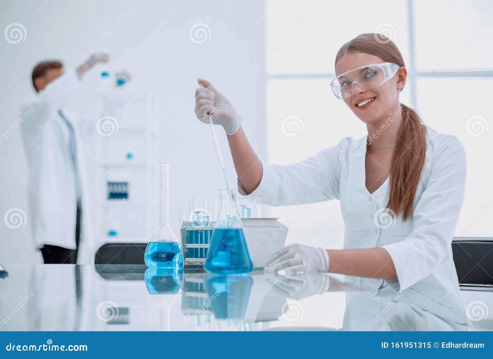 Young Lab Technician Sitting at a Table in the Lab. Stock Image - Image ...
