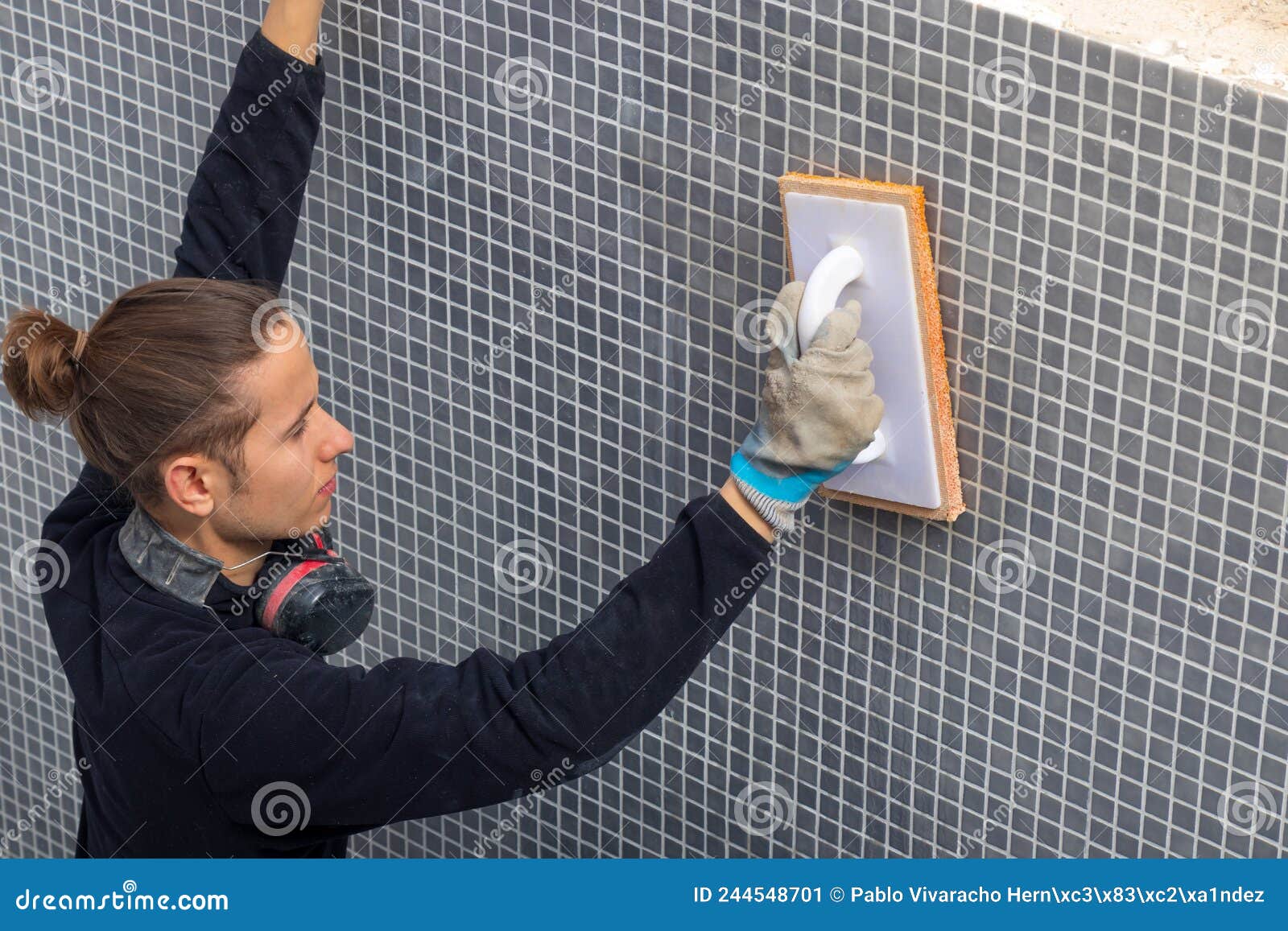 Young Laborer Man Working on a Swmming Pool Tiling with a Plastering ...