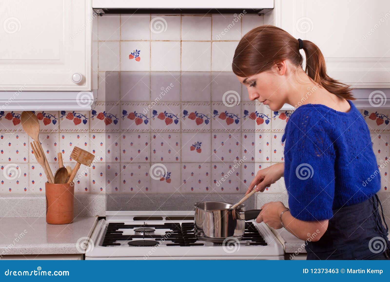 Young Lady Cooking stock image. Image of person, kitchen - 12373463