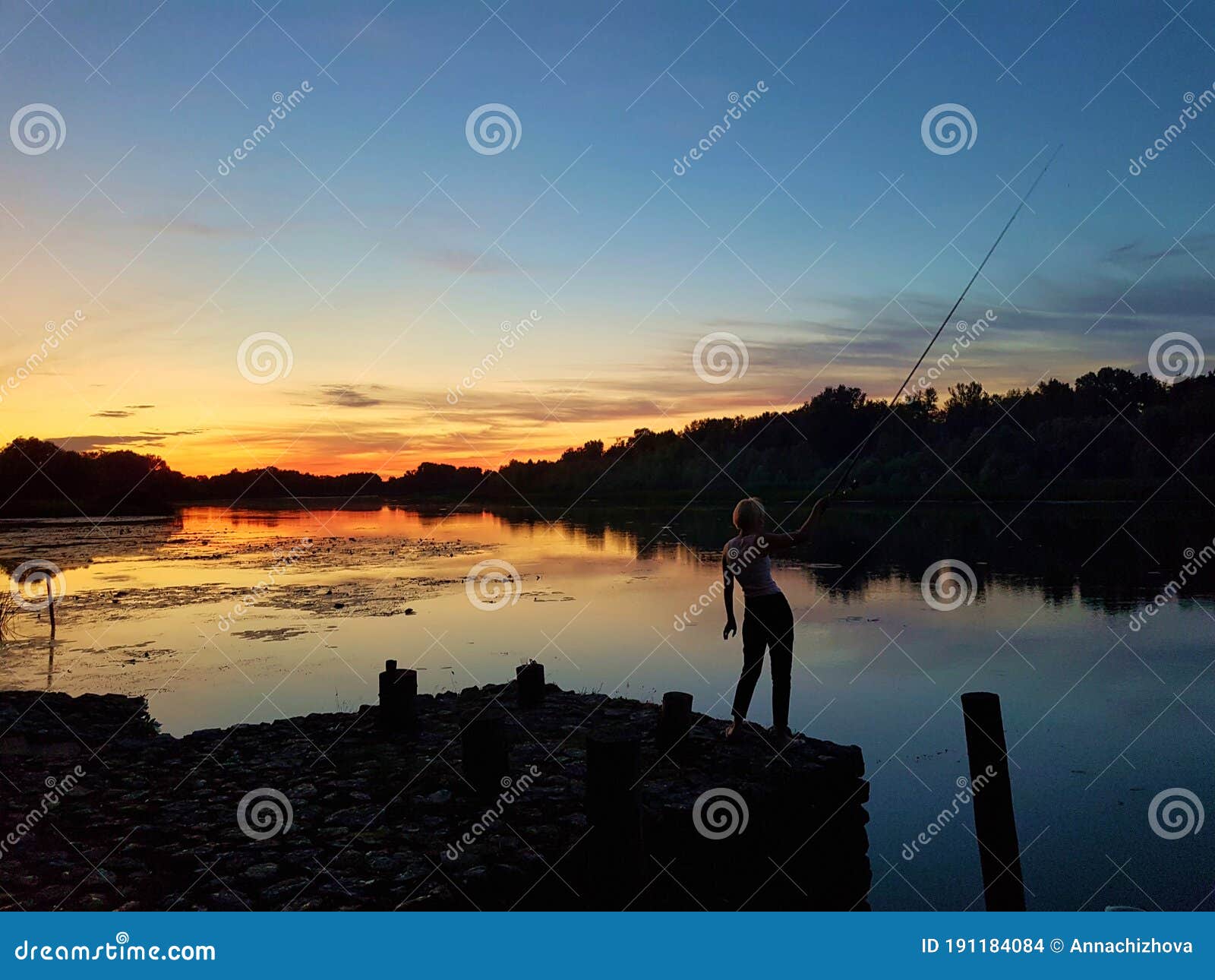 Young Lady Fishing on the River at Sunset Stock Photo - Image of ...